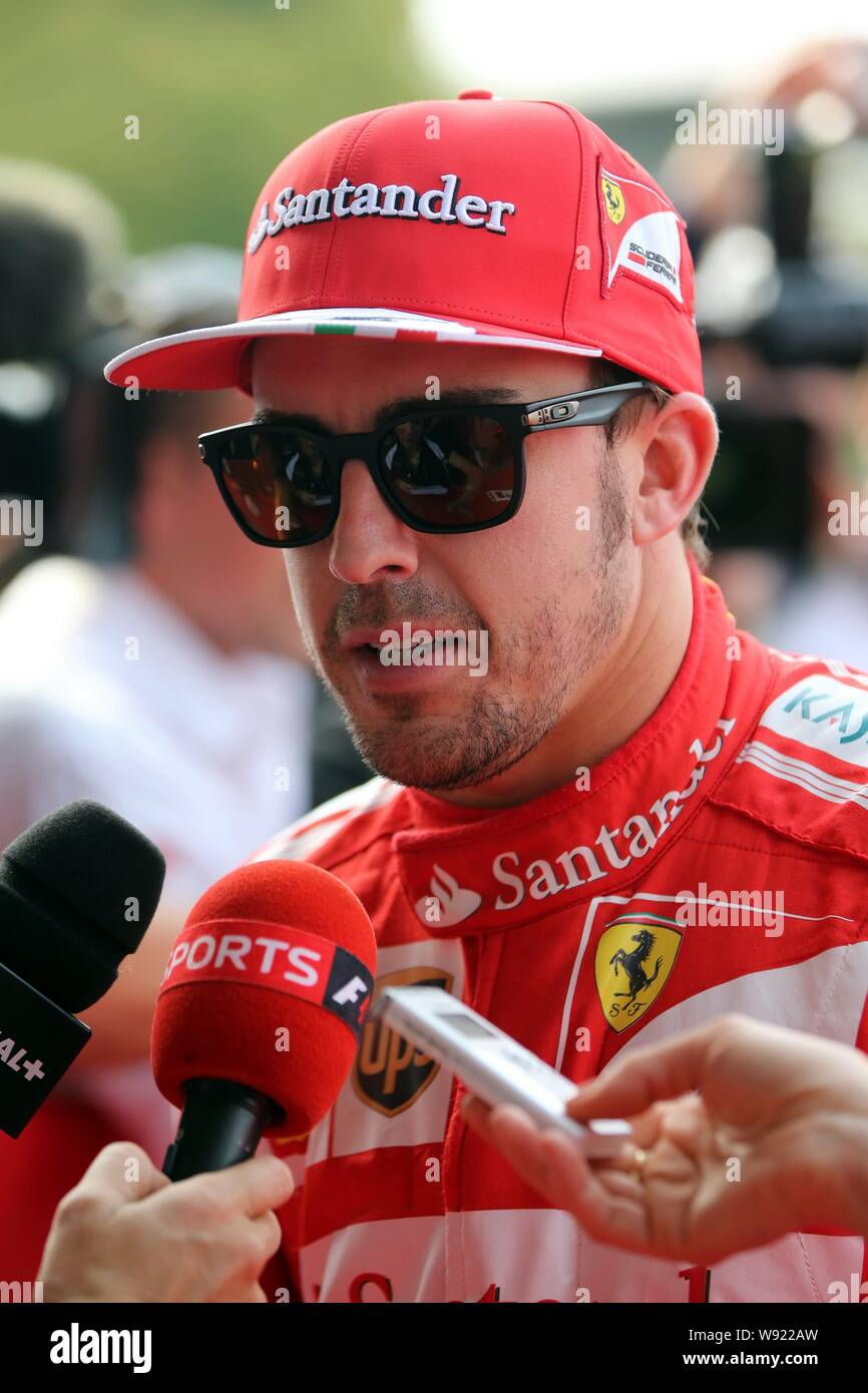 Spanish F1 driver Fernando Alonso of Ferrari is interviewed after the ...