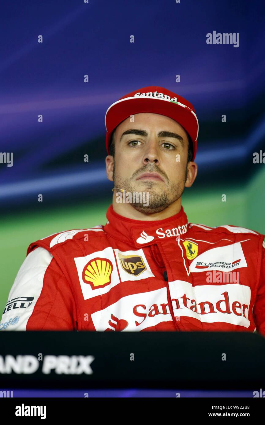 Spanish F1 driver Fernando Alonso of Ferrari looks on at a press ...