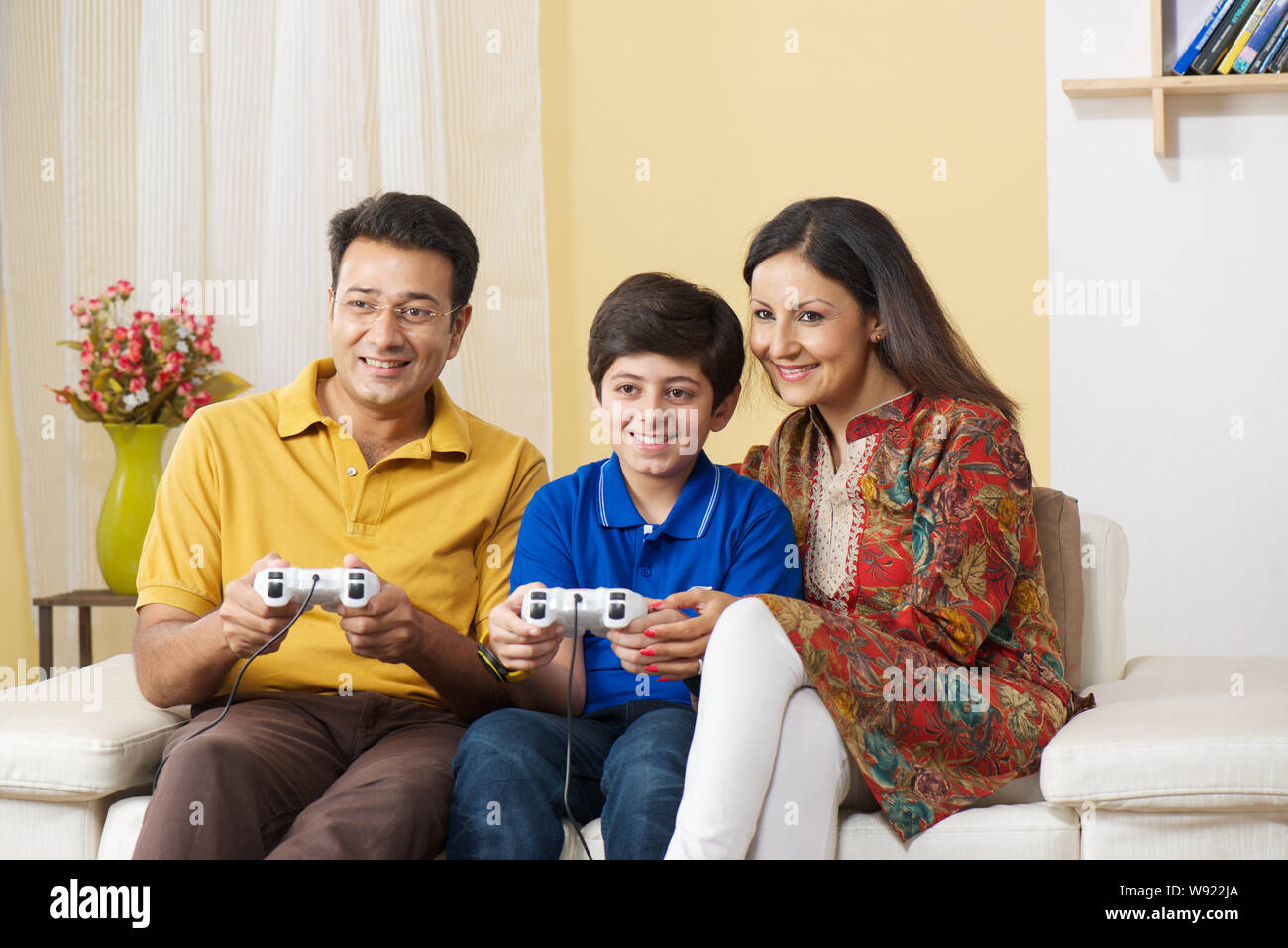 Family playing video game at home Stock Photo - Alamy