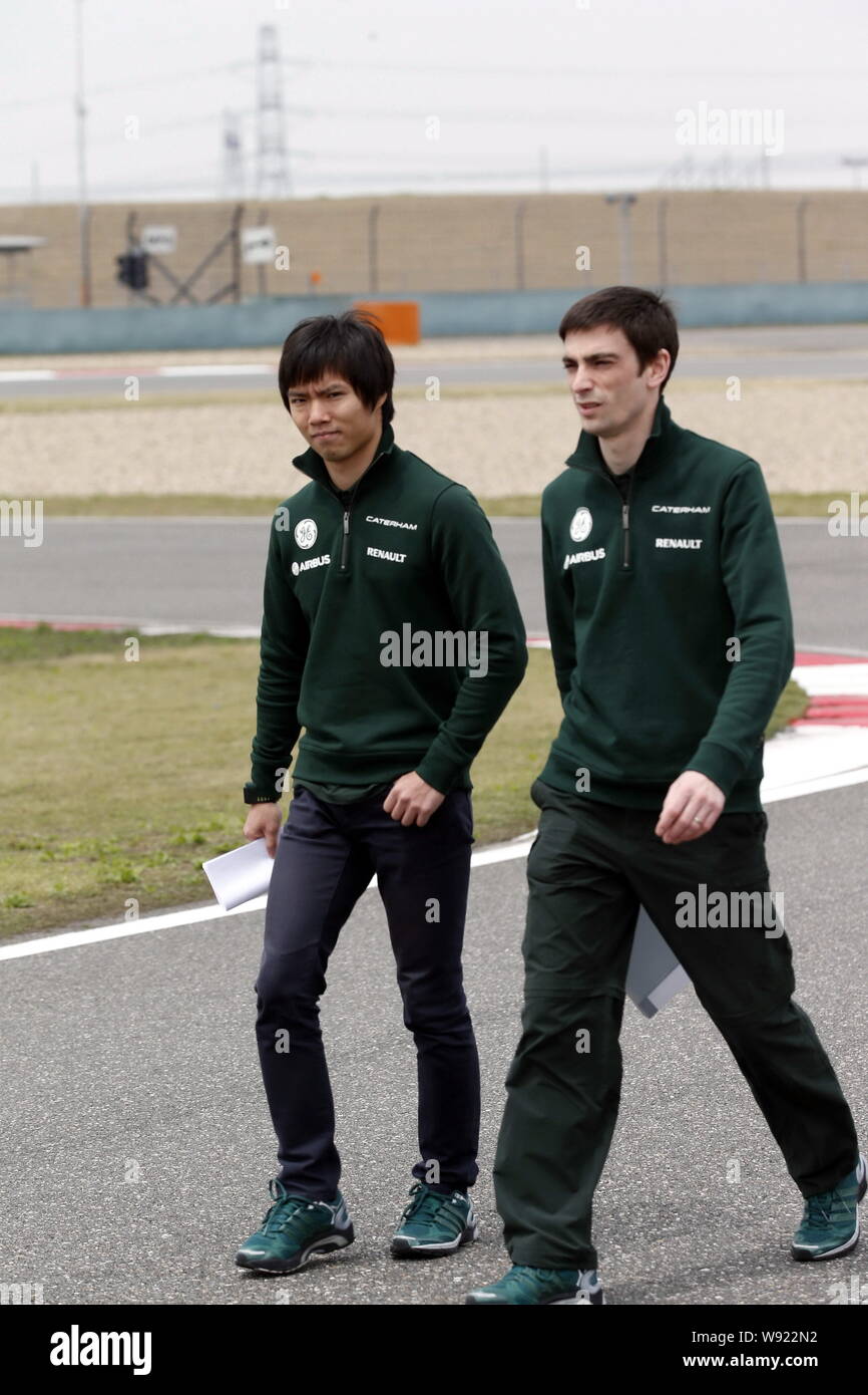 Chinese racer Ma Qinghua of Caterham, left, and his teammates walk ...