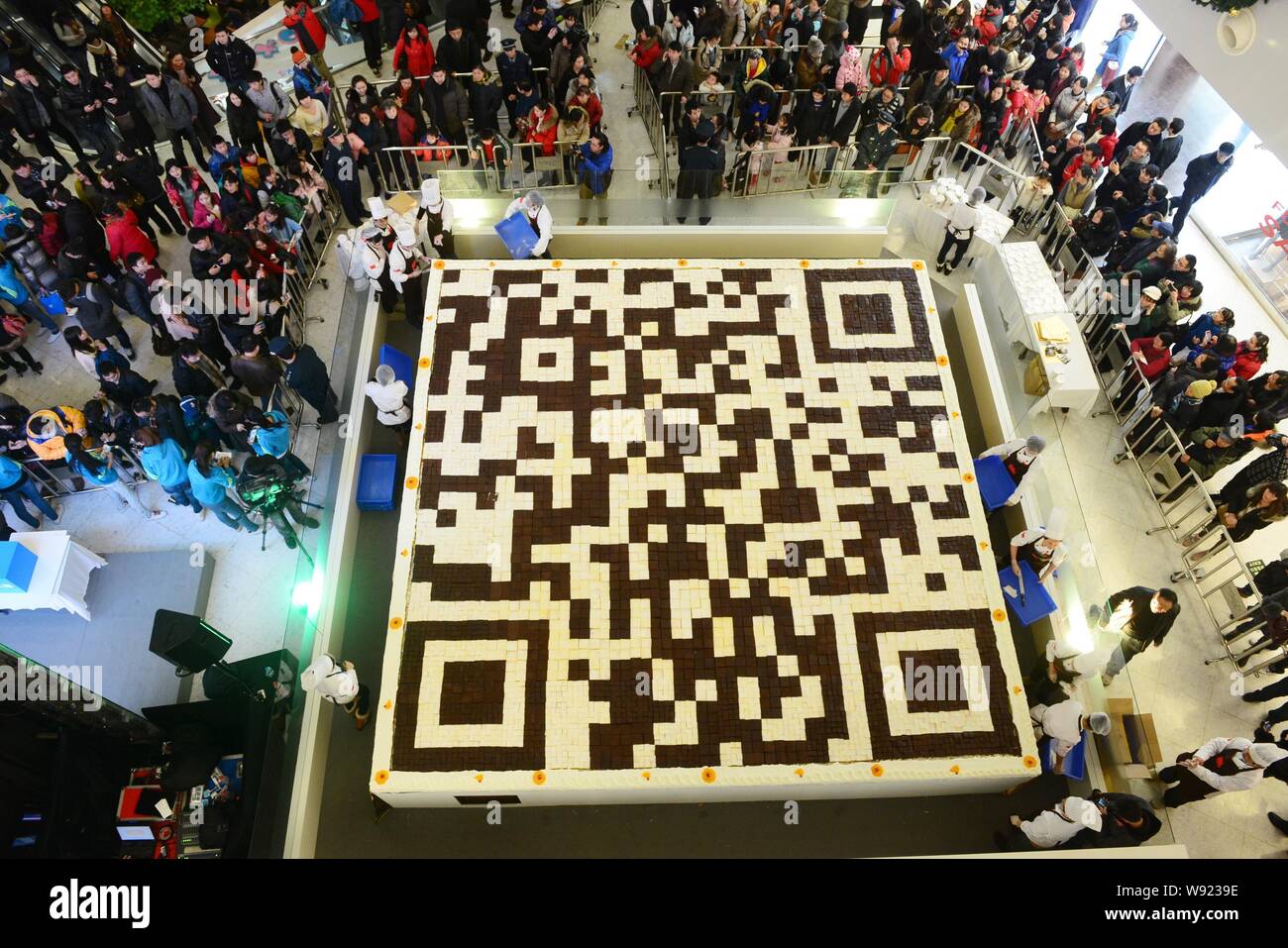 Shoppers look at a giant QR code cake displayed at Raffles City ...
