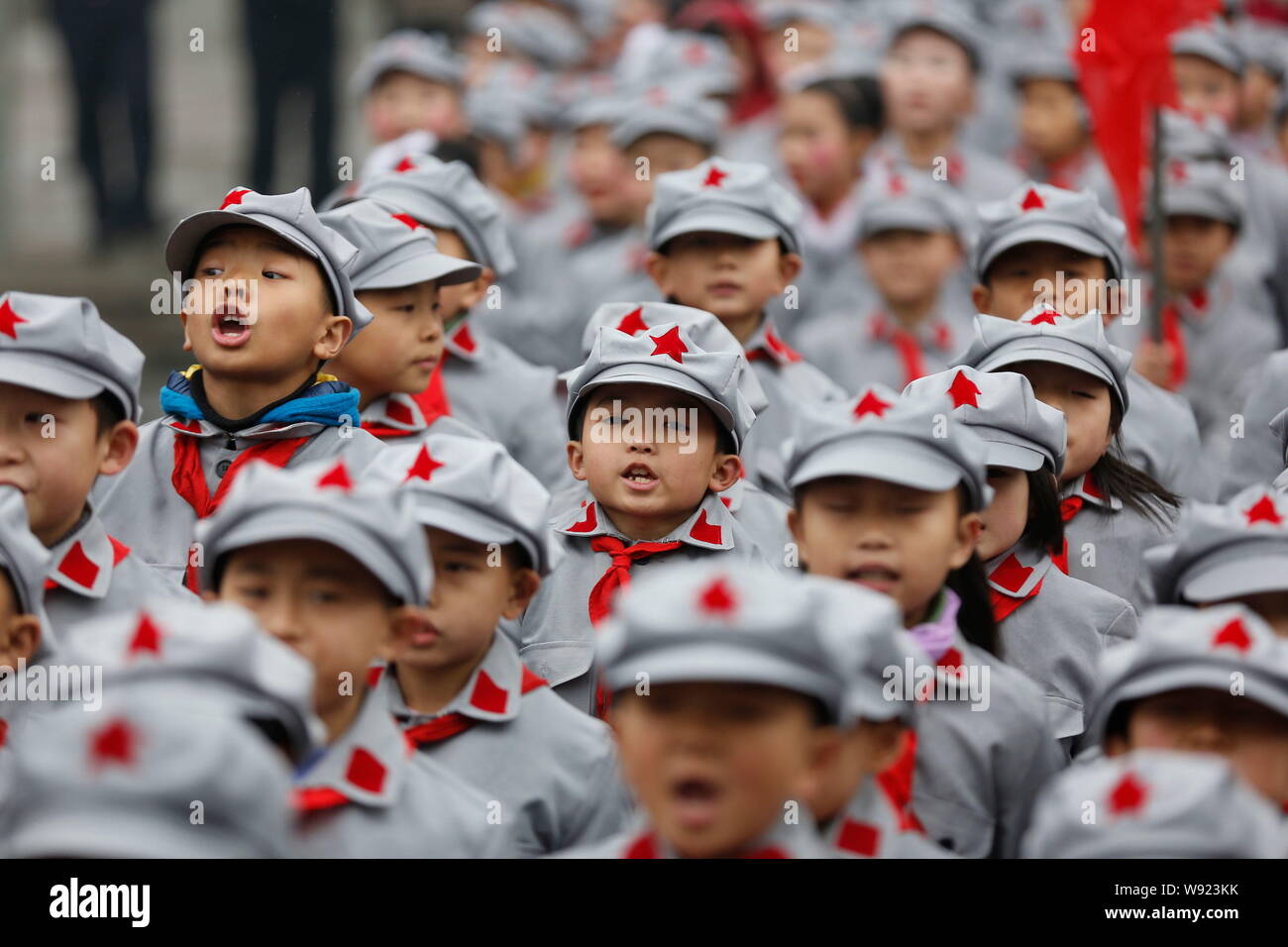 Young Chinese students dressed in Red Army costumes sing a song during ...