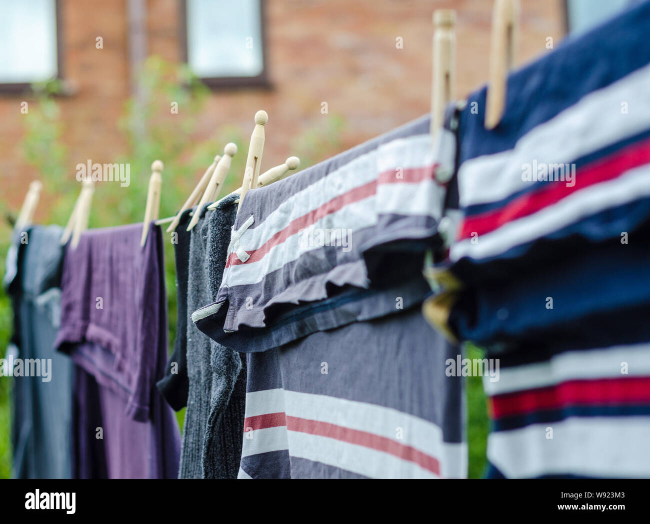 Clothes hang on a washing line in a garden to dry Stock Photo - Alamy