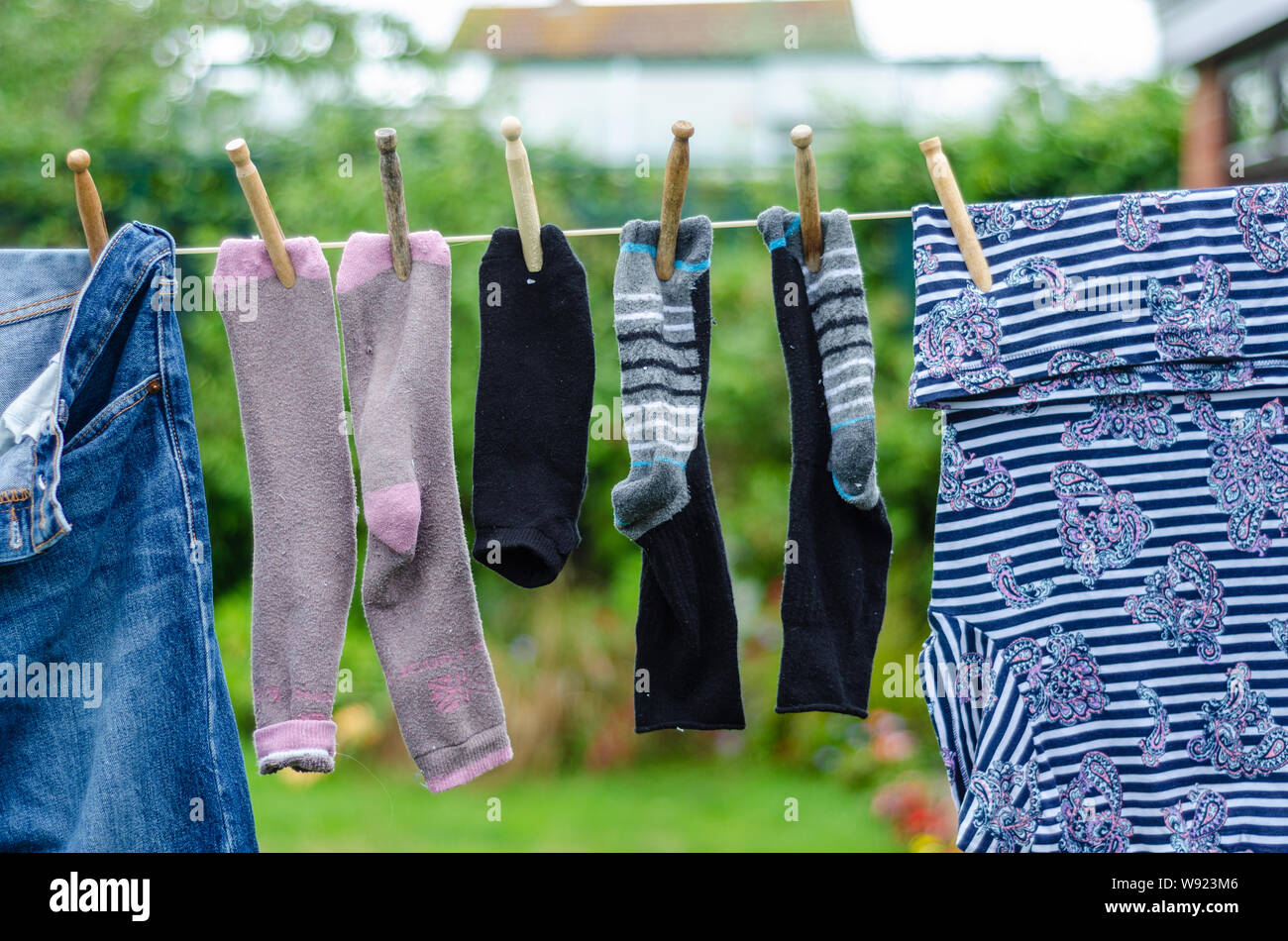 Socks drying on a washing line in a residential garden Stock Photo - Alamy