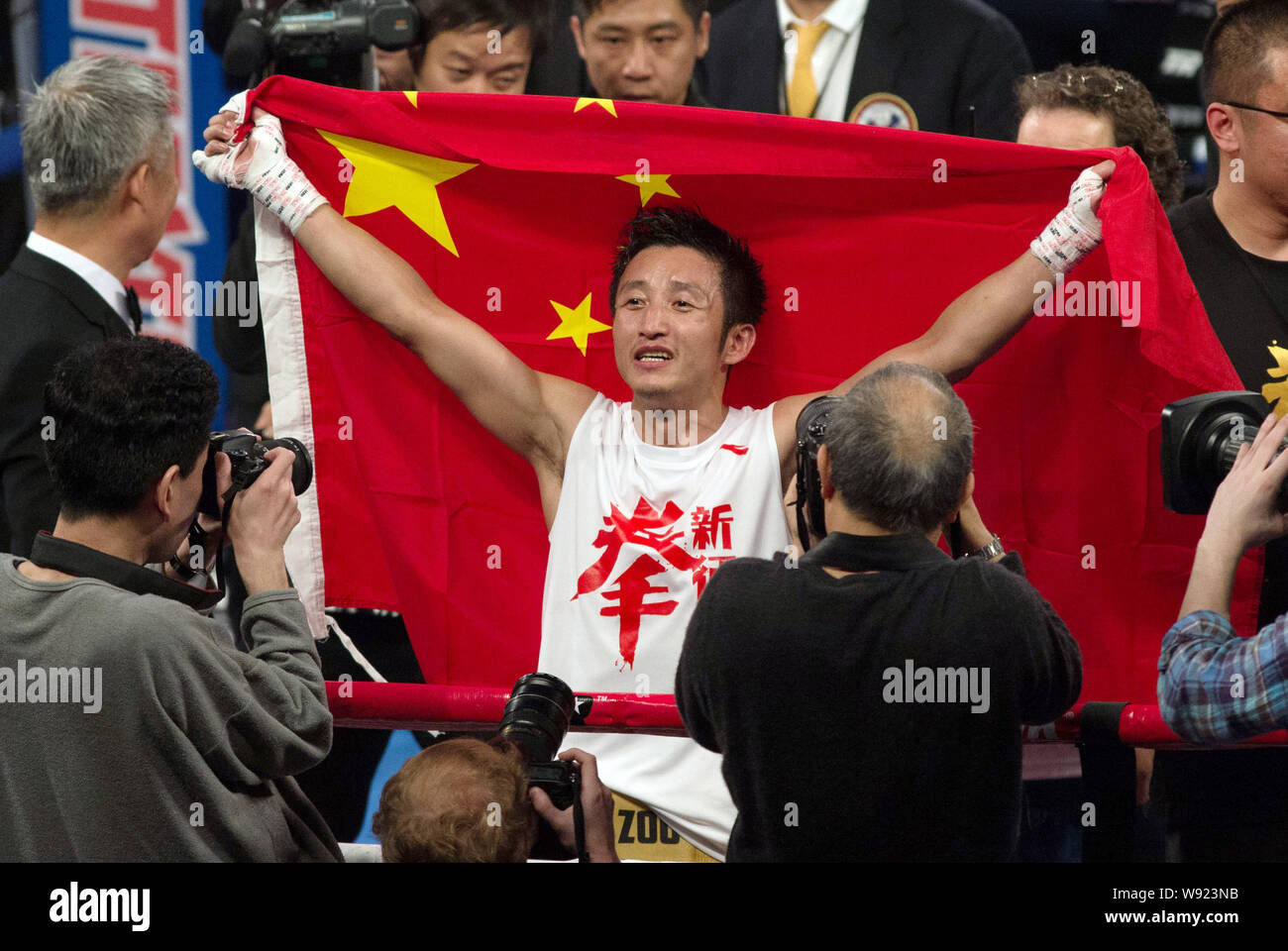 Chinese Olympic boxing champion Zou Shiming (center) waves a Chinese ...