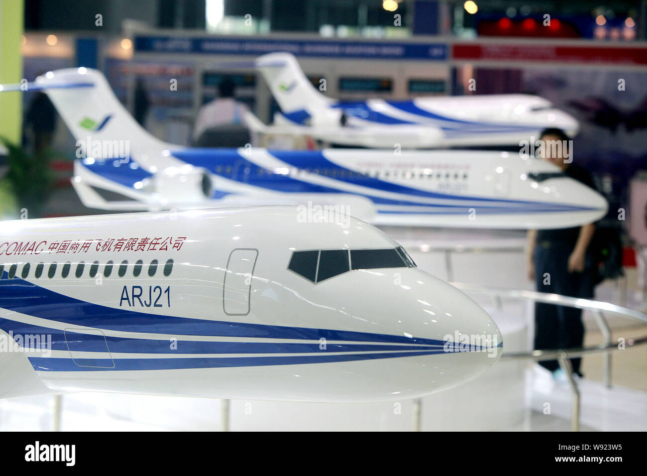 --FILE--Visitors look at models of the Chinese-developed ARJ21 regional ...