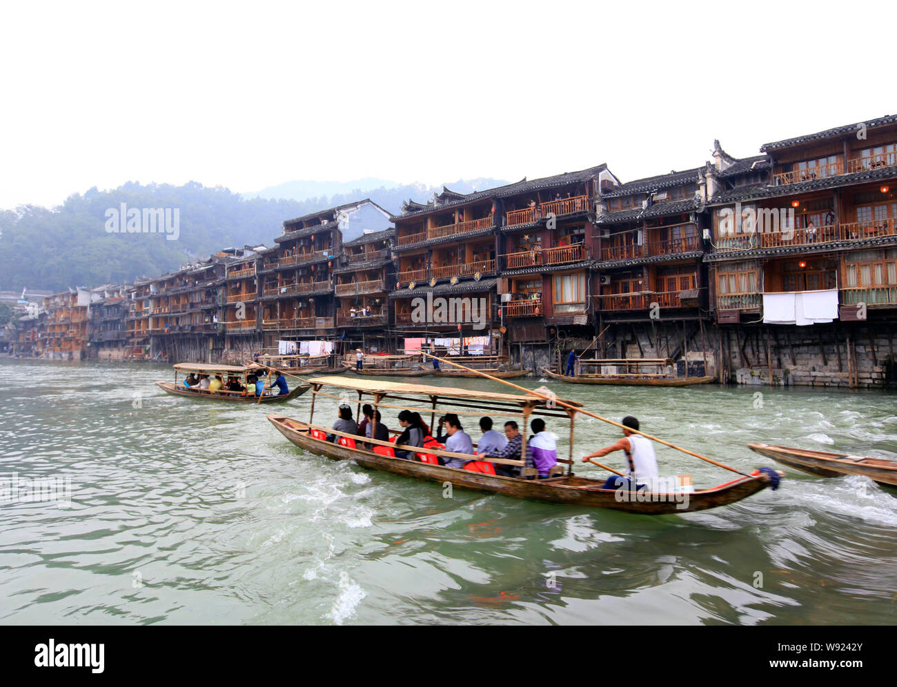 People visit the Fenghuang ancient town scenic area in during the week ...