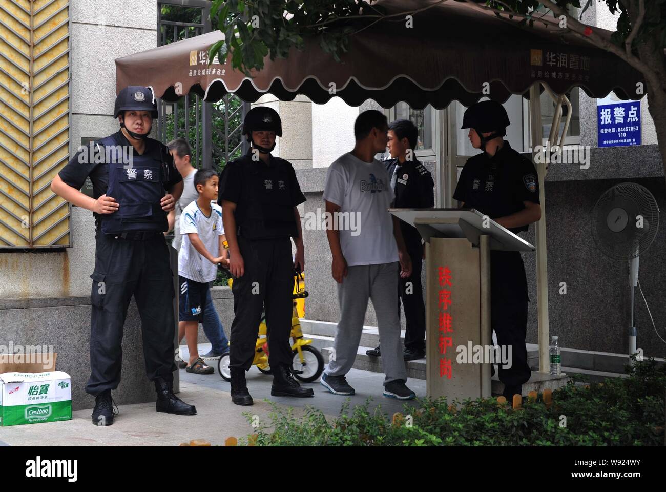 Local police officers are seen outside a housing estate after gunshots ...
