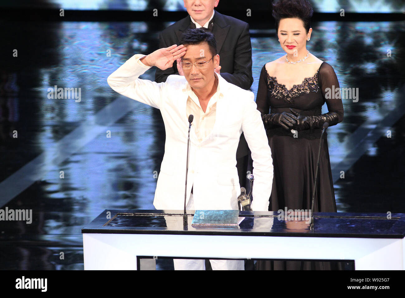 Hong Kong actor Tony Leung Ka Fai, front, poses with his award for Best Actor for Cold War at ...