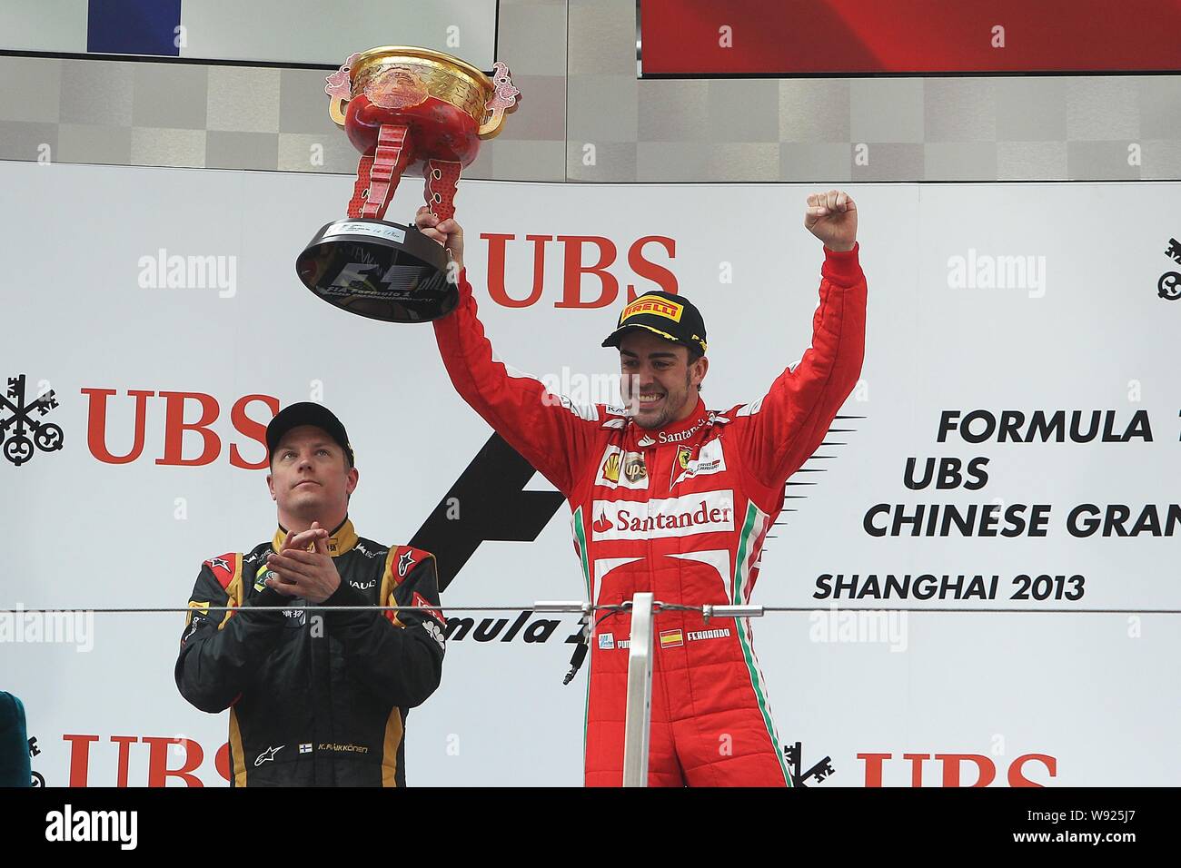 Spanish F1 driver Fernando Alonso of Ferrari, right, celebrates with ...