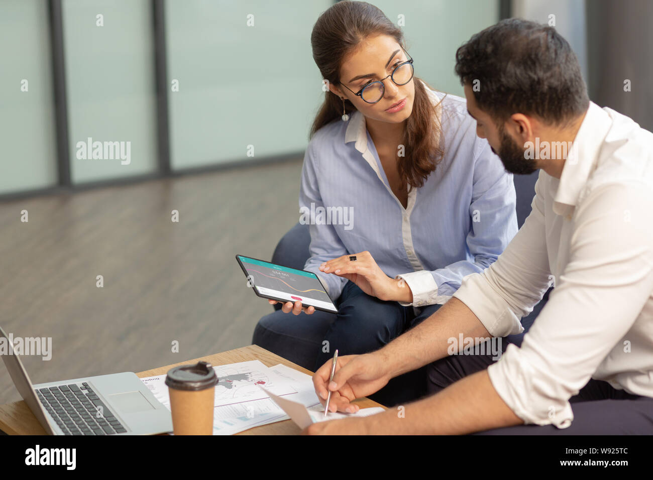 Attentive female person listening to her colleague Stock Photo - Alamy