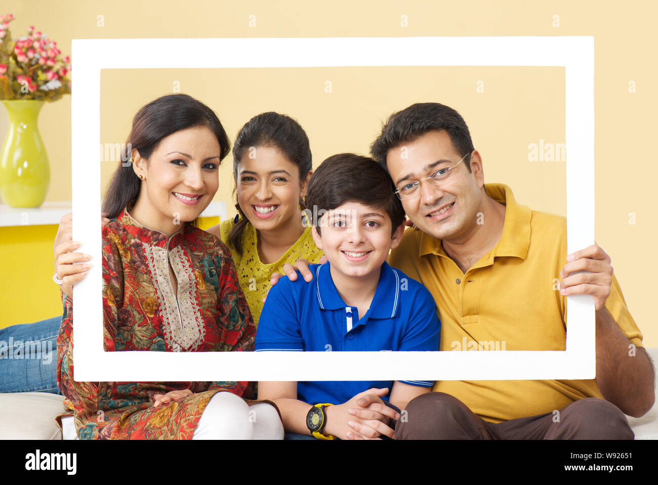 Family holding frame and smiling Stock Photo - Alamy