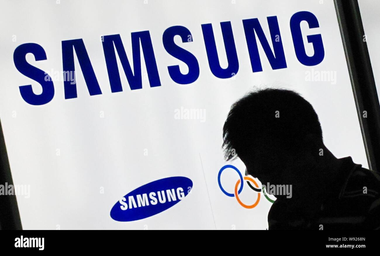 --FILE--A pedestrian walks past an advertisement of South Korean ...