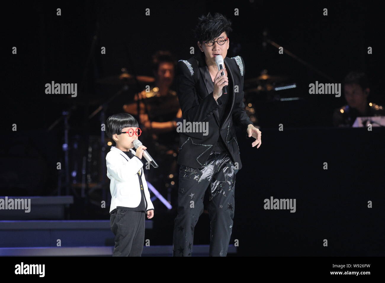 Singaporean singer JJ Lin, right, performs with a young Chinese kid ...