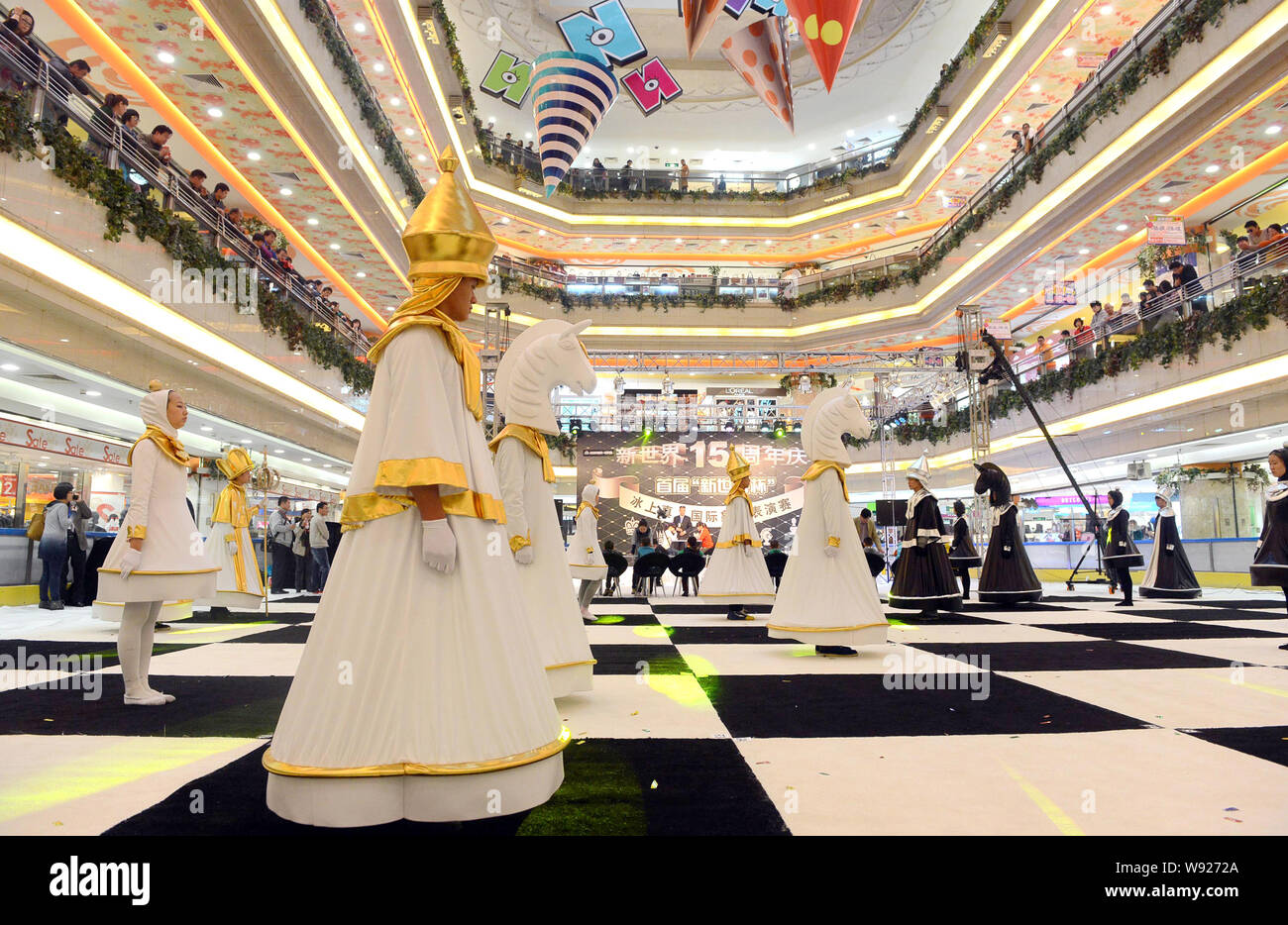 Performers dressed in chess costumes take part in a chess contest at ...