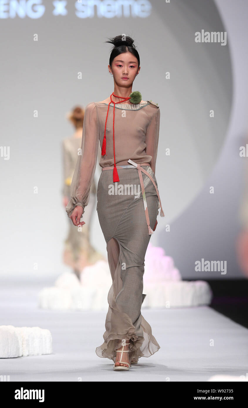 A model displays a new creation by female Chinese designer Ji Cheng at ...