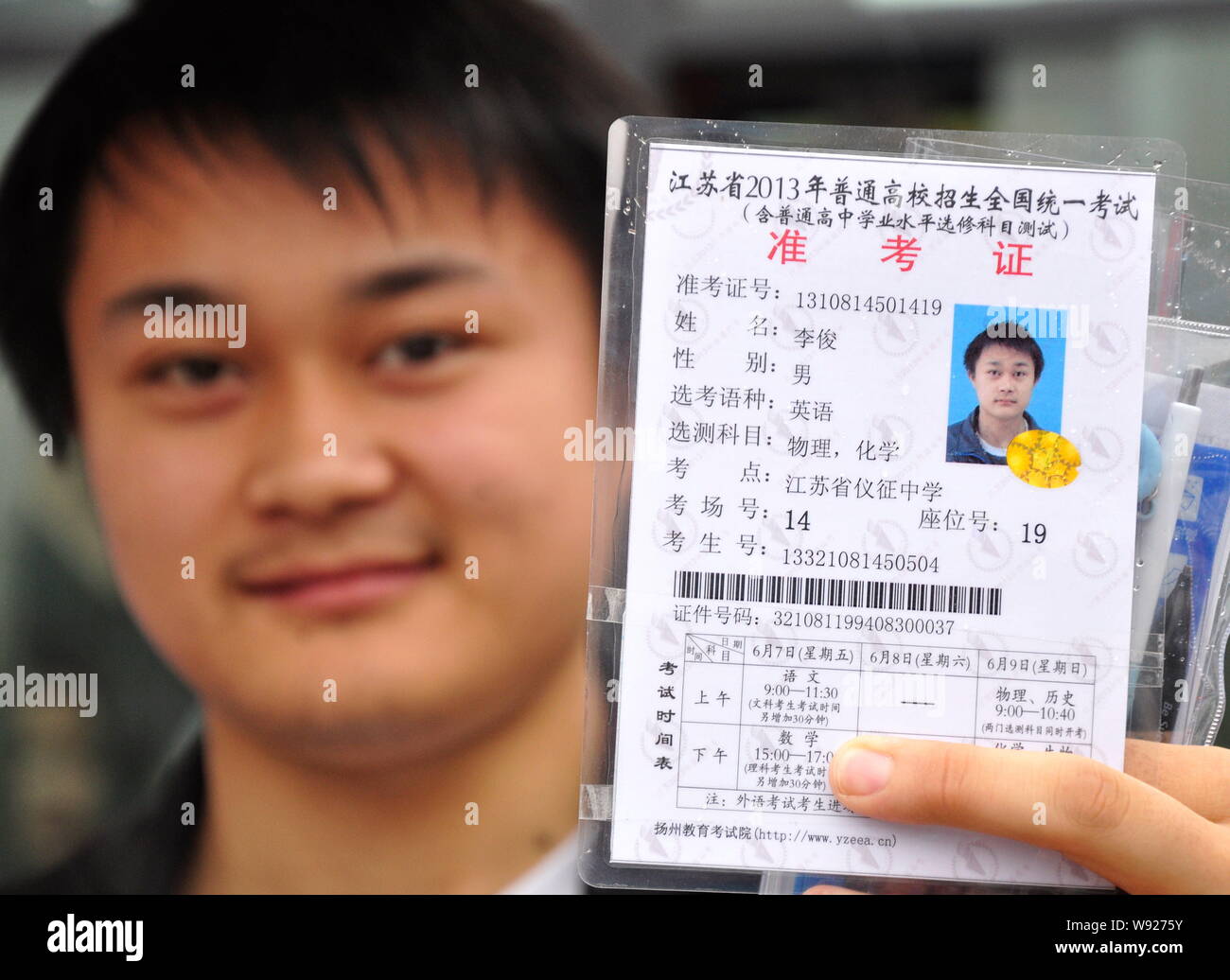 A Chinese examinee shows his text permit for the annual national ...