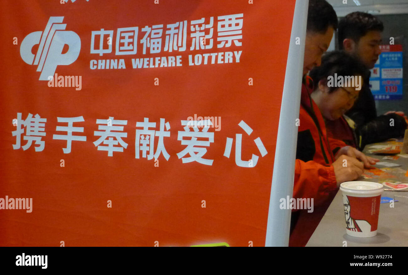 --FILE--Chinese residents scratch lottery tickets at an office of the ...