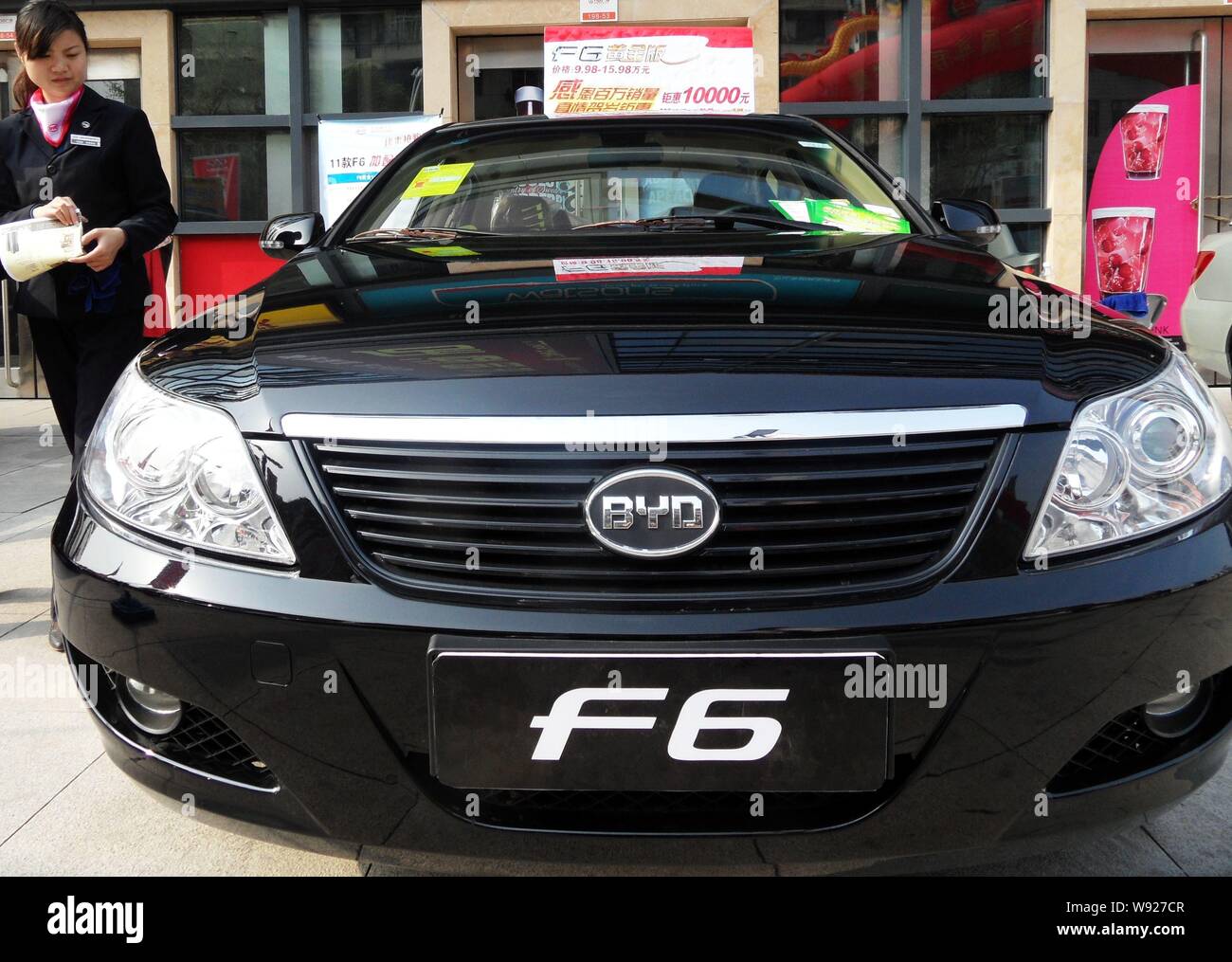 --FILE--A Chinese employee works at the stand of BYD during an ...