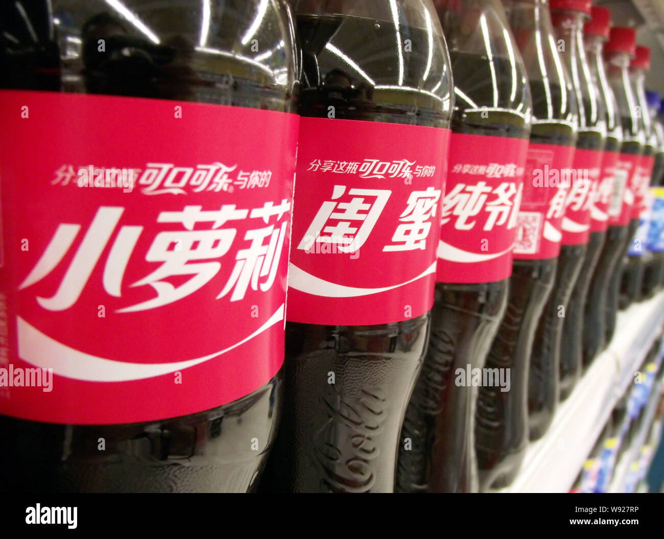 Bottles of Coca-Cola with new packaging are for sale on the shelf at a ...
