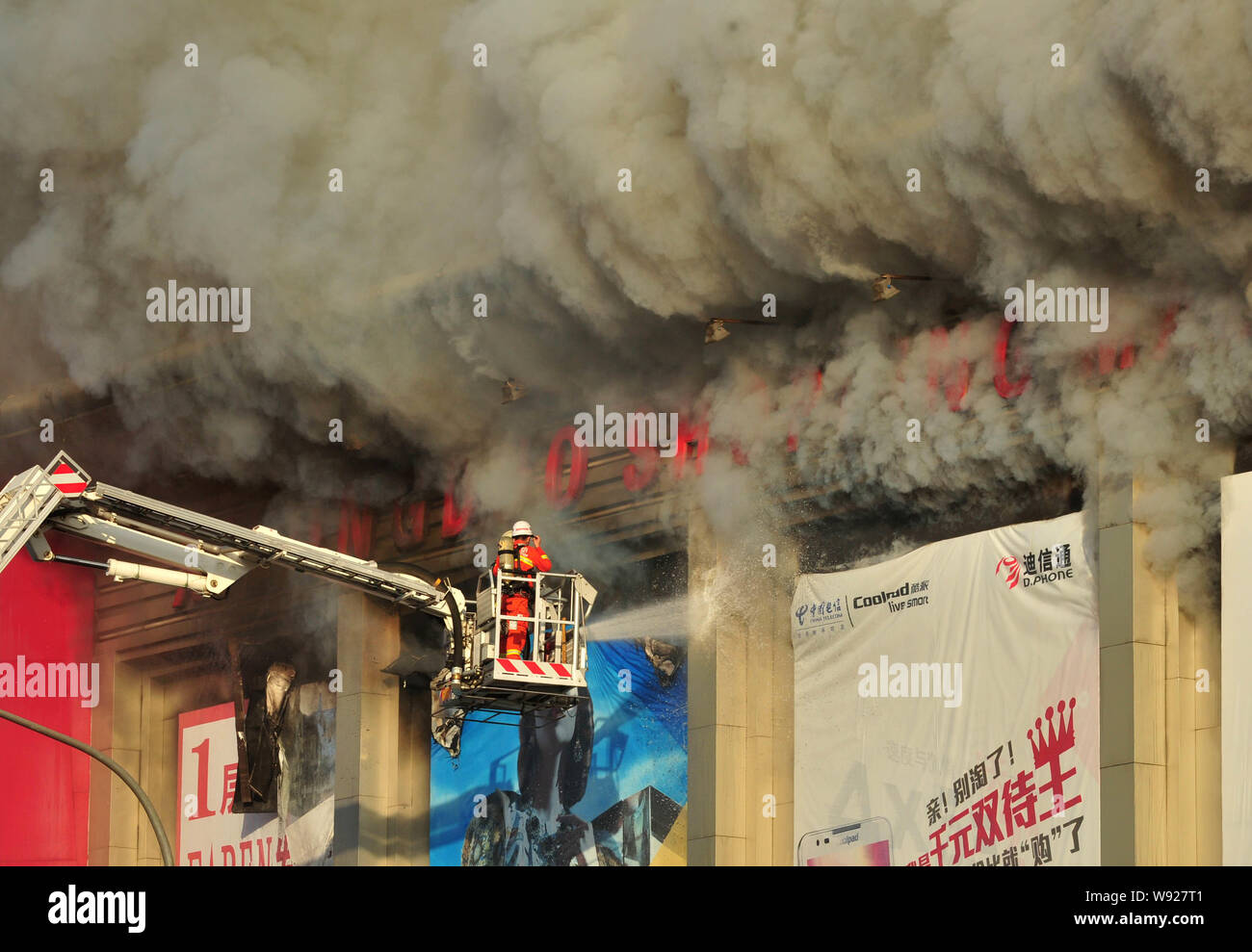 Chinese firefighters hose water to extinguish the fire in the Xilongduo ...