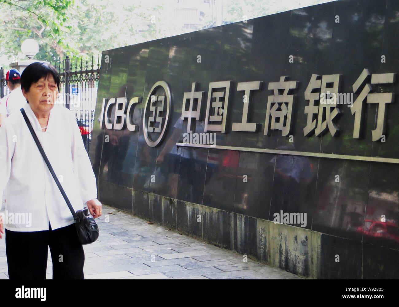 --FILE--A pedestrian walks past a logo of Industrial and Commercial ...