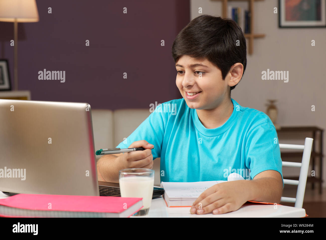 Boy studying at home Stock Photo - Alamy