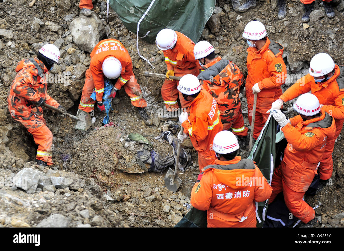 Rescuers search for the workers buried in the rubble after the ...