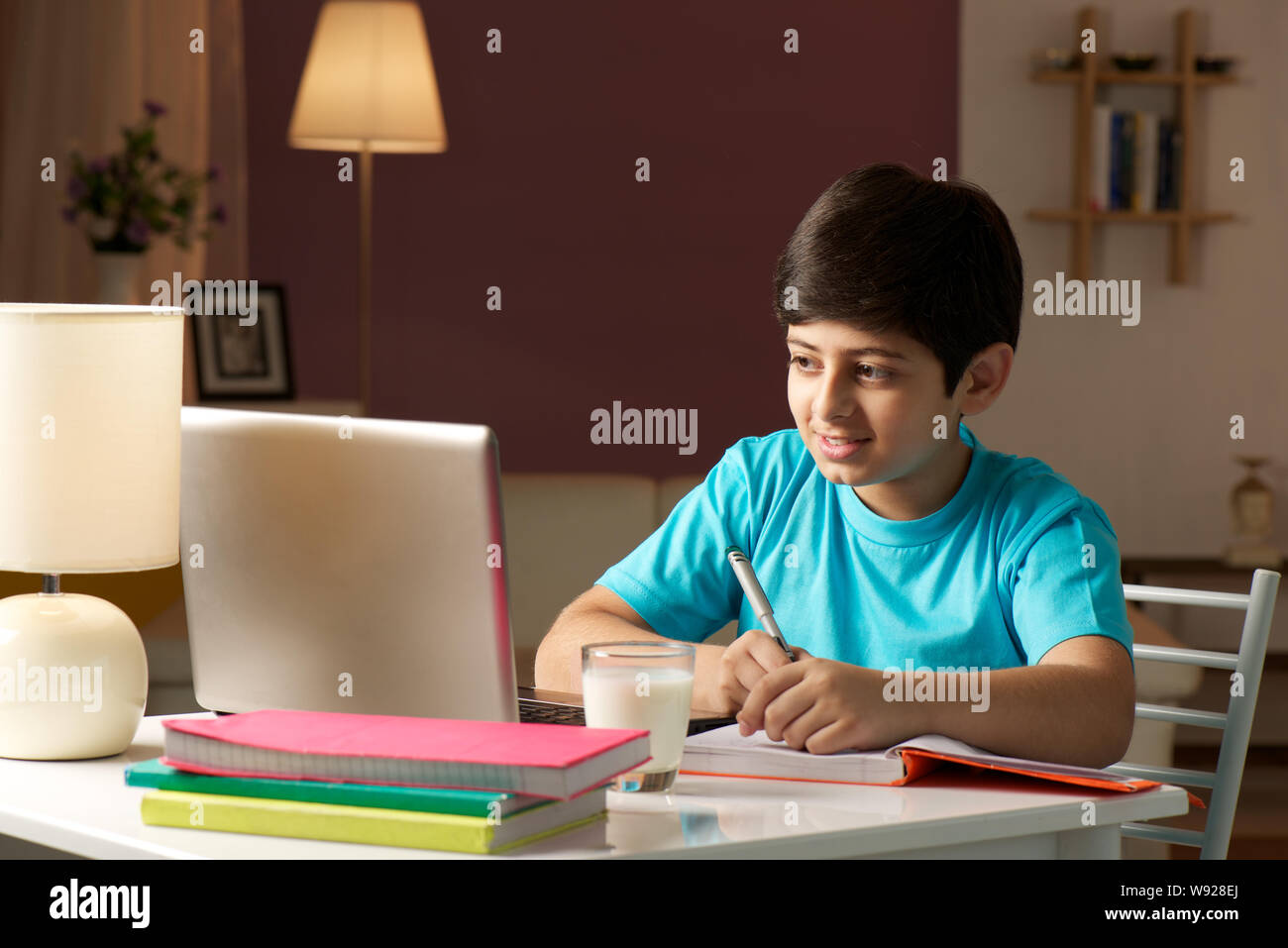 Boy studying at home Stock Photo - Alamy