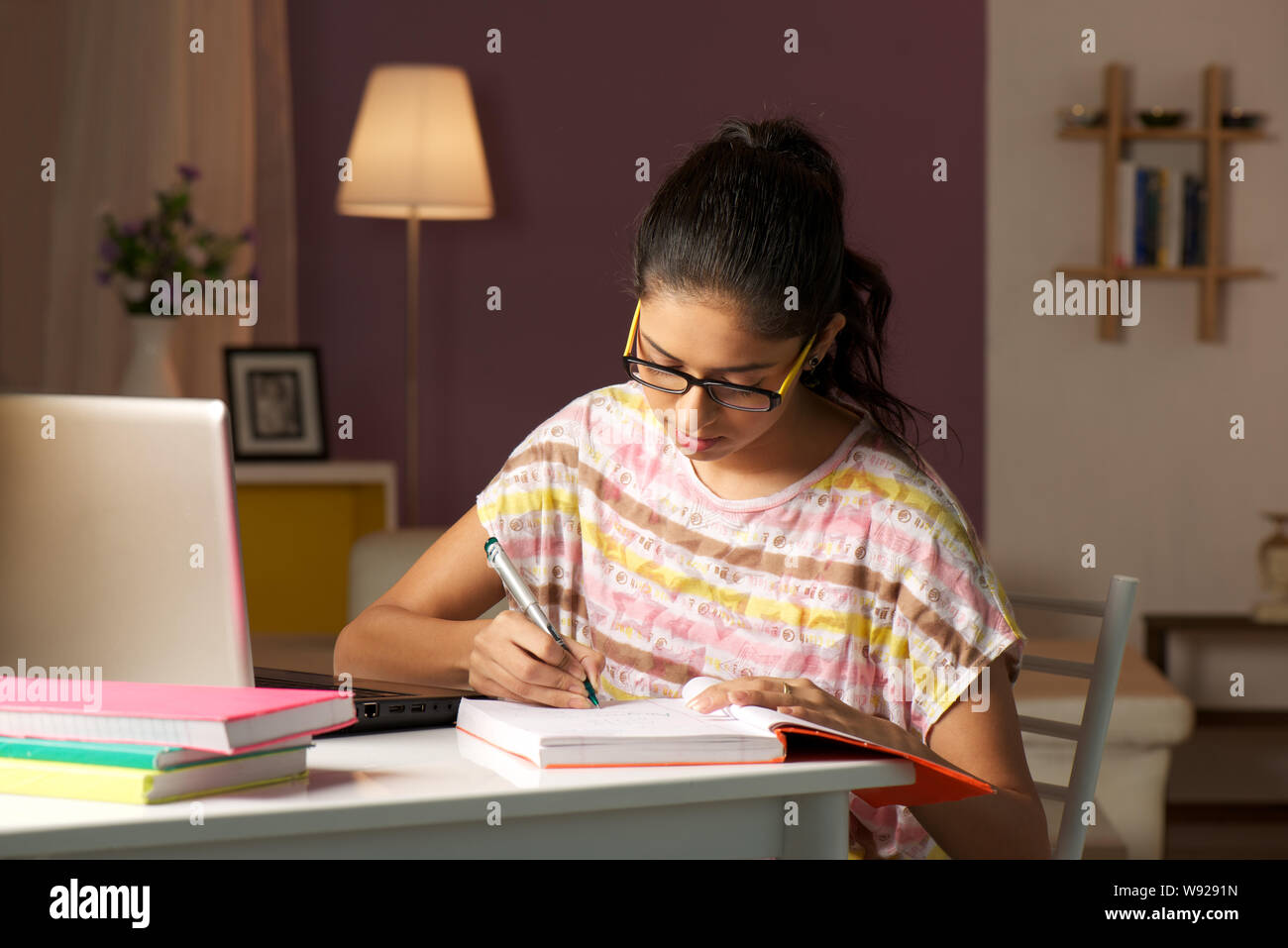 Teenage girl studying at home Stock Photo - Alamy