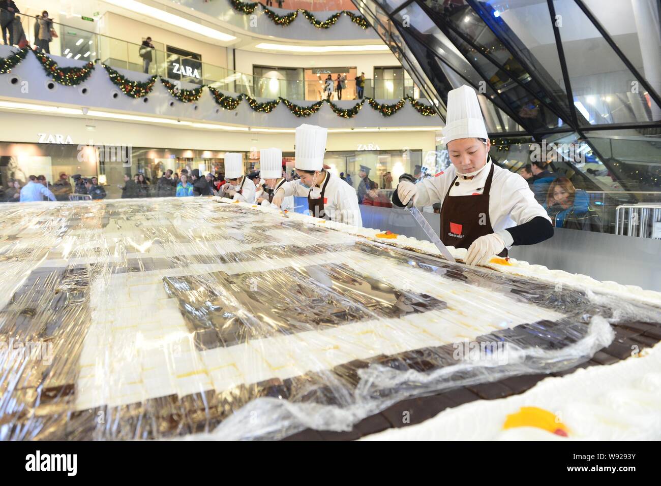 Bakers put final touches on a giant QR code cake displayed at Raffles ...
