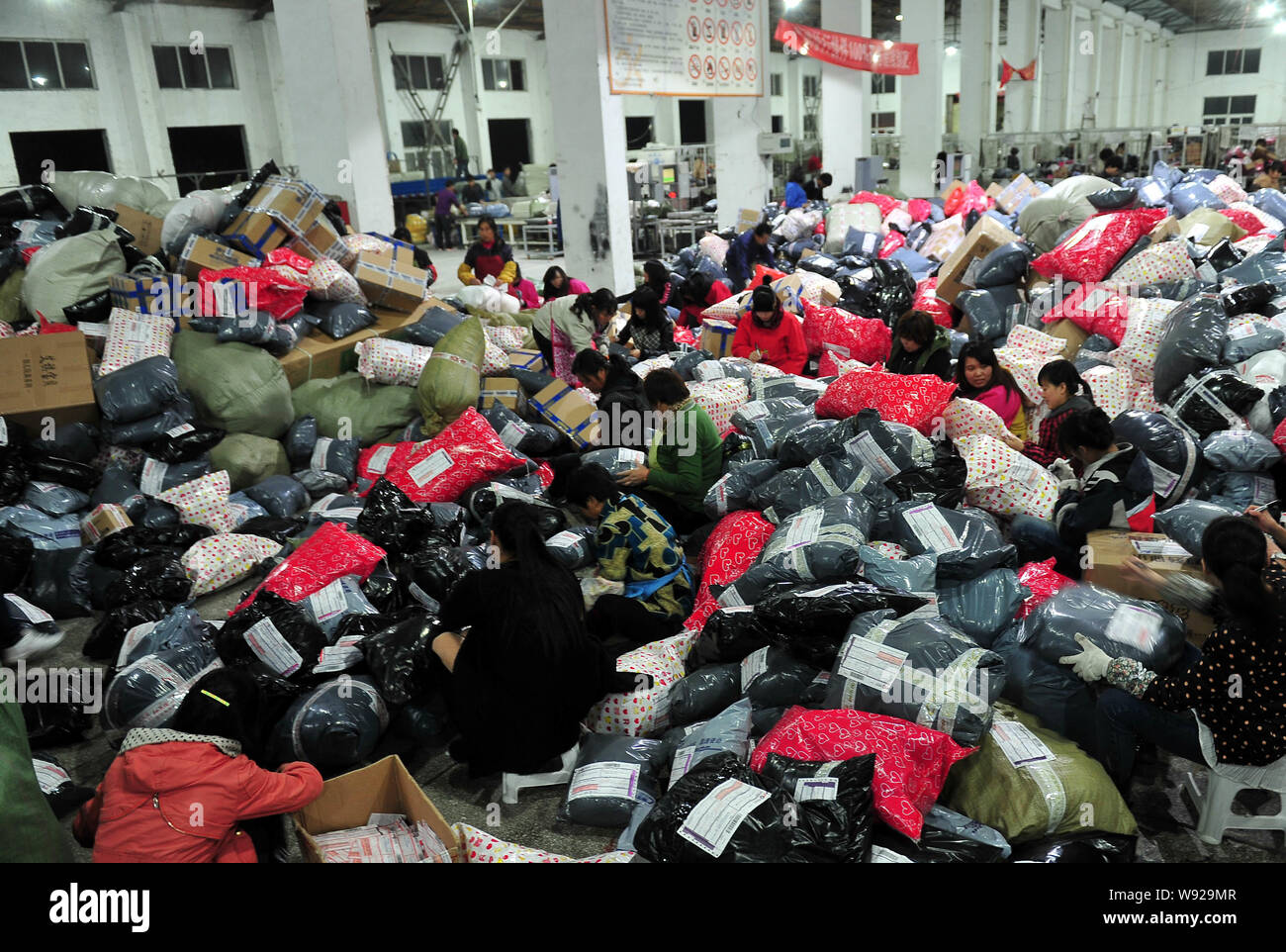 Chinese workers sort parcels, most of which come from online shopping ...