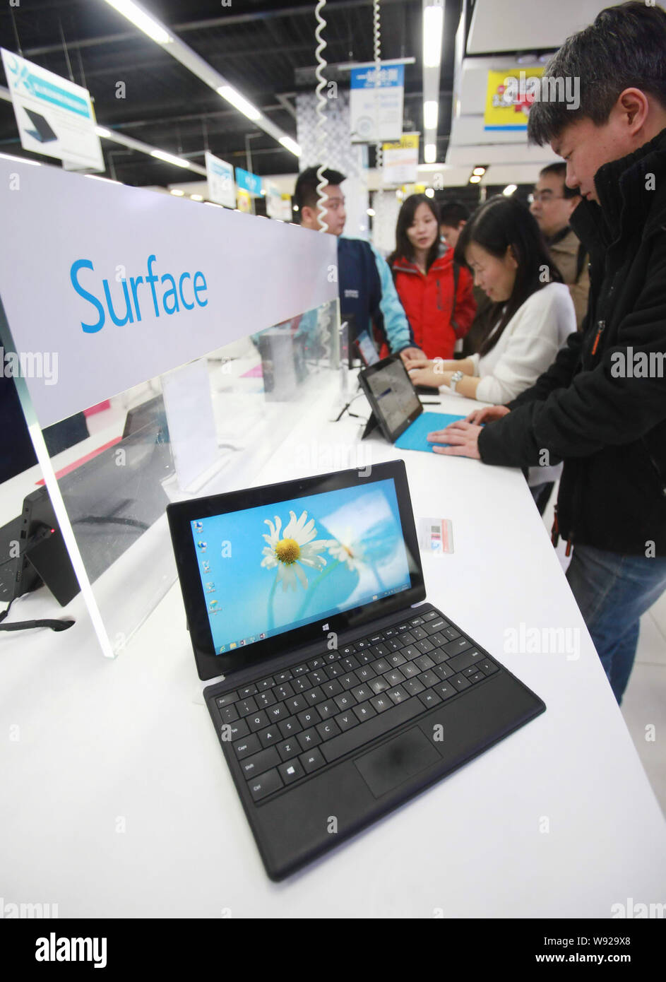 Chinese shoppers try out Microsoft Surface Pro tablet PCs at a home ...