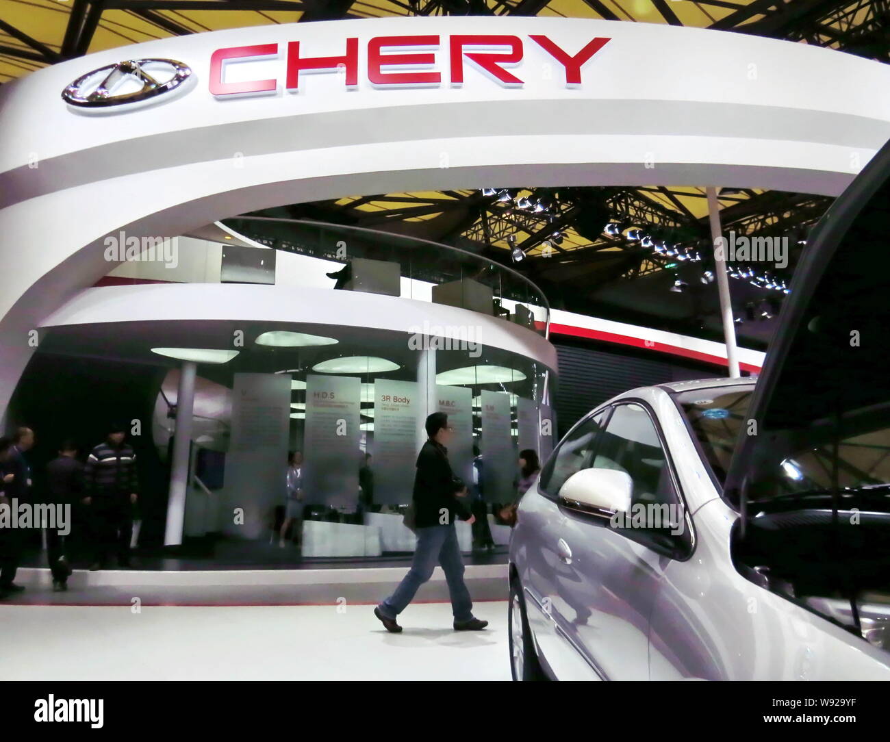 --FILE--A visitor walks past the stand of Chery during the 15th ...