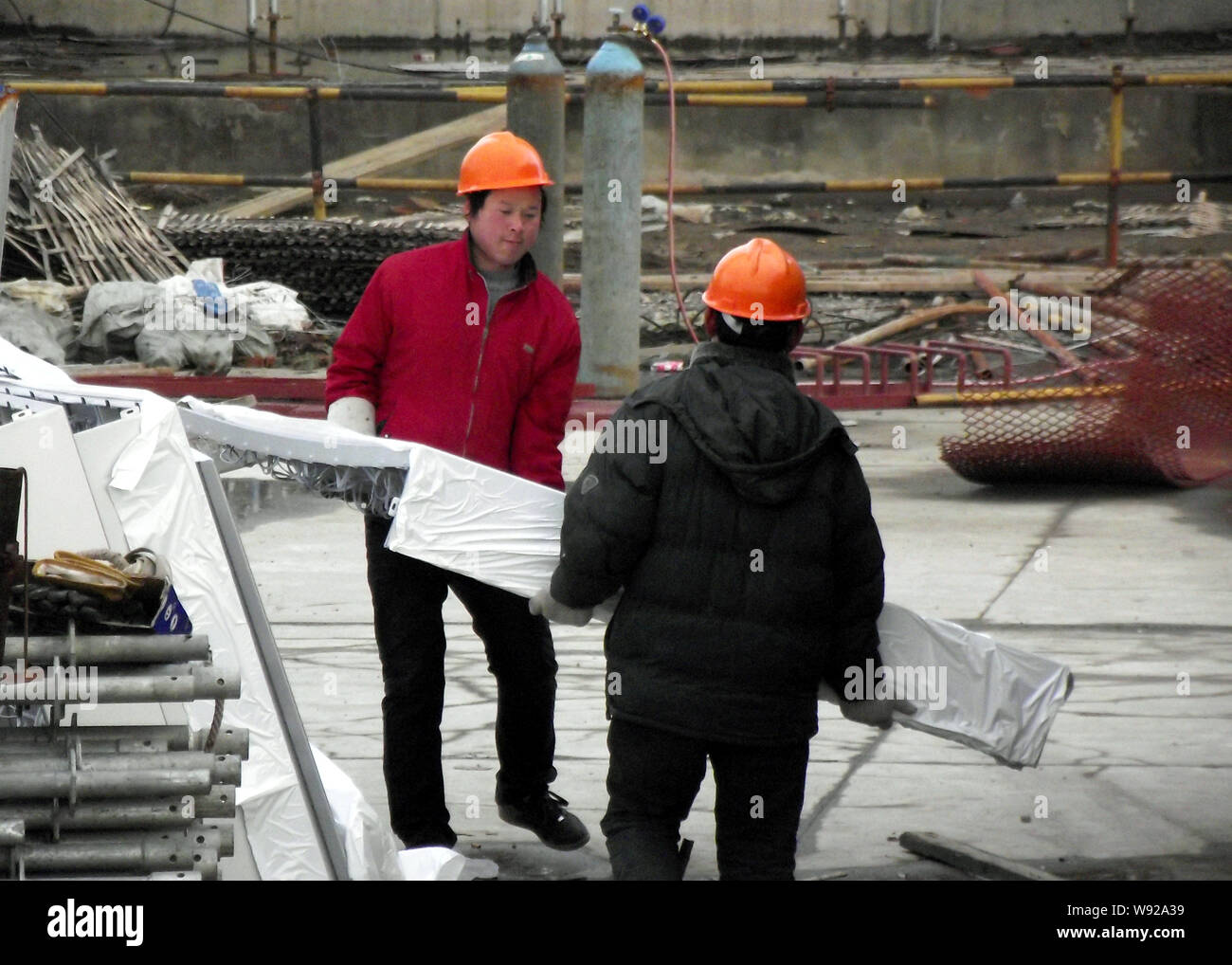 Builders carry construction material on the work site of the worlds ...