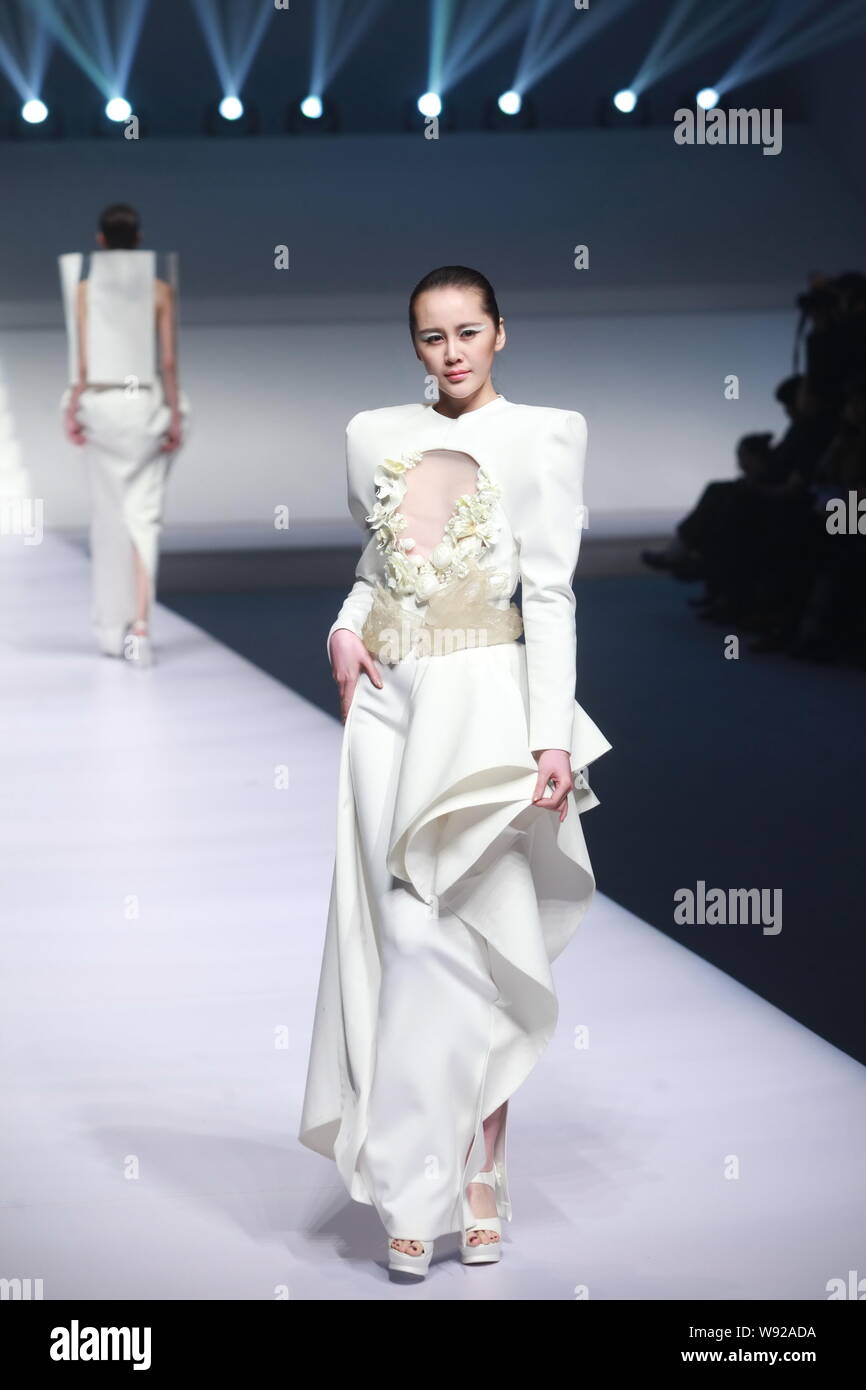 A model displays a new creation during the 21st China International ...