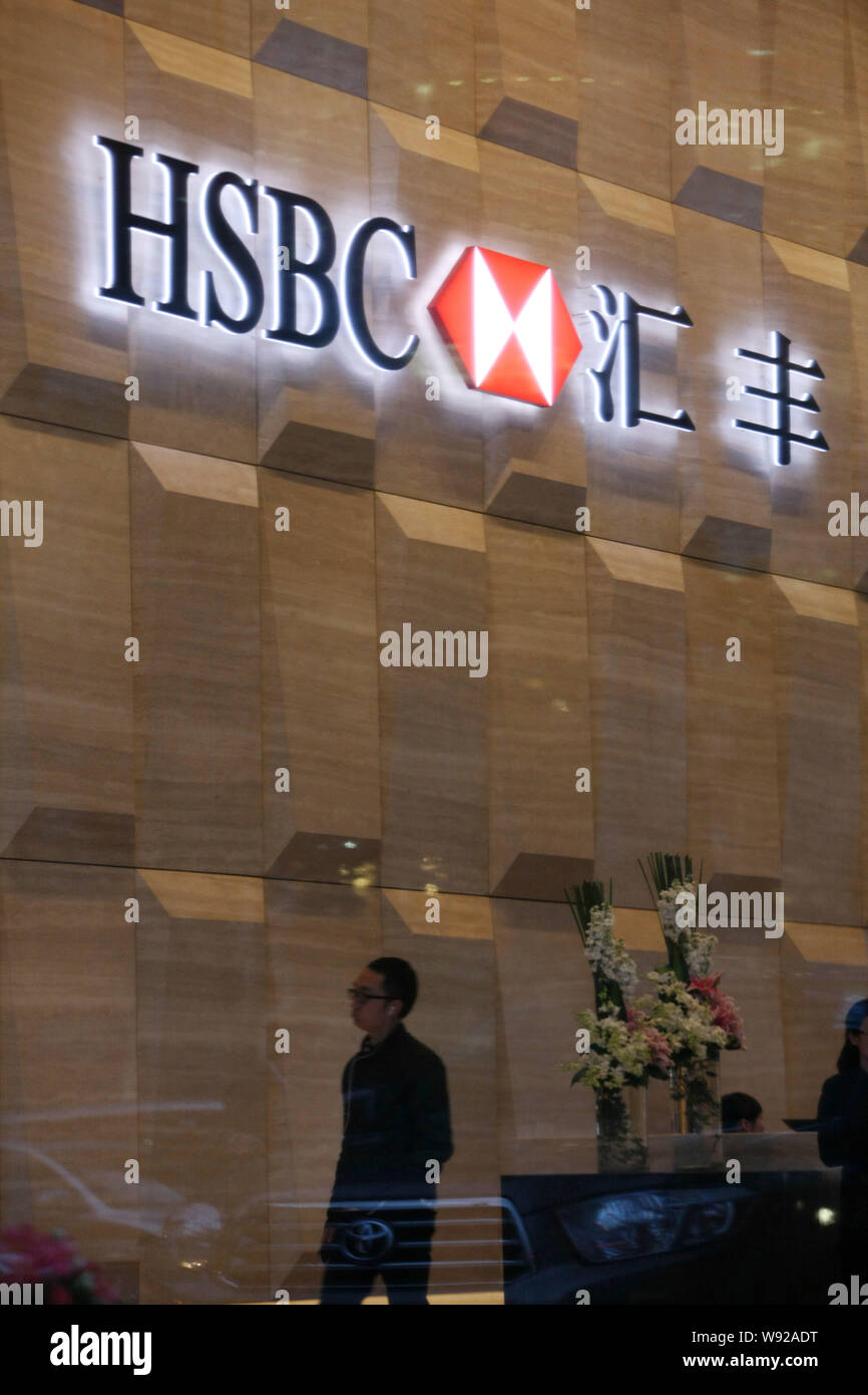 People walk past the front desk at the China headquarters of HSBC in ...