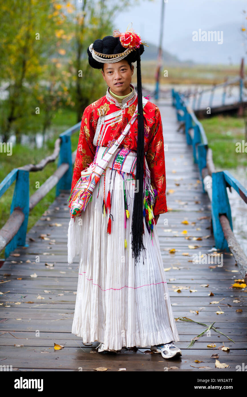 --FILE--Al young Mosuo lady stands beside the Lugu Lake, situated in ...