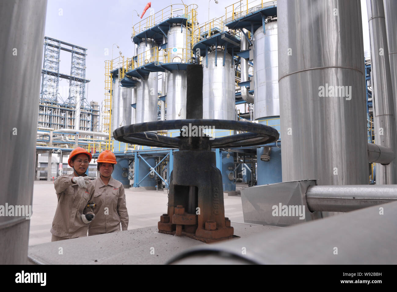 --FILE--Chinese workers examine refining equipment at a refinery of ...