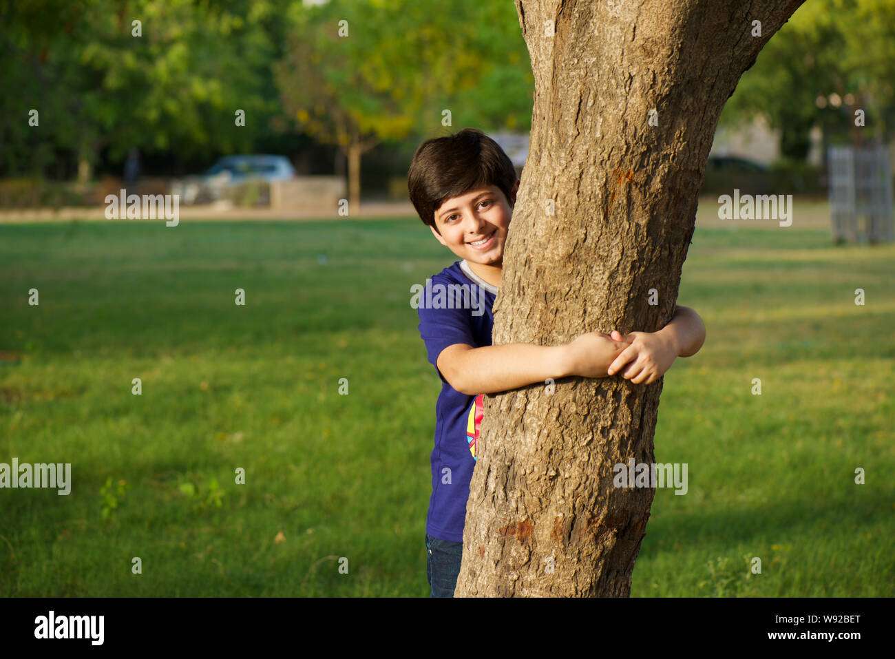 Boy hugging tree hi-res stock photography and images - Alamy