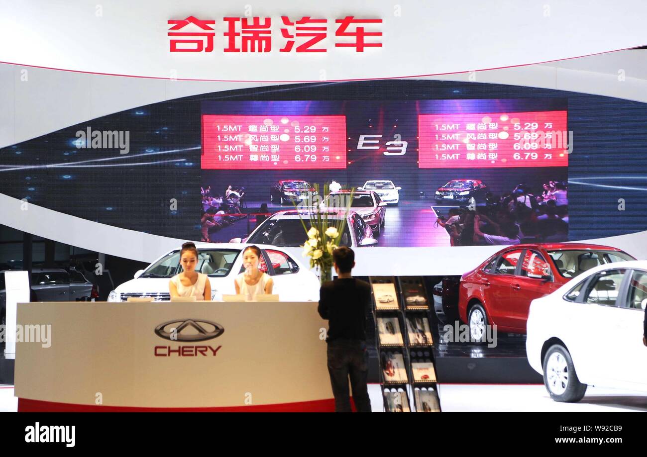 --FILE--Employees are seen the stand of Chery during an automobile ...