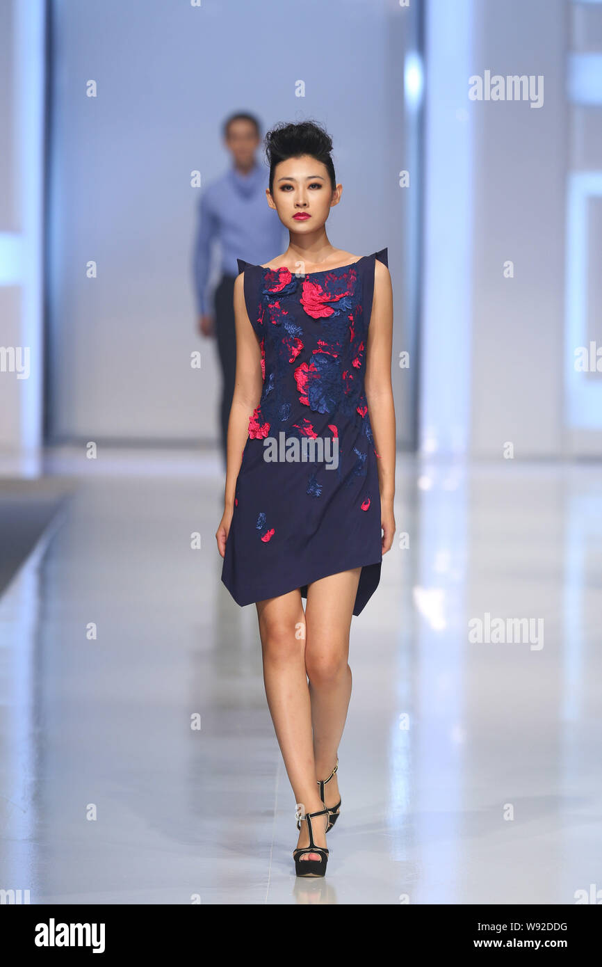 A model displays a new creation by Chinese brother designers Wu Xuewei ...