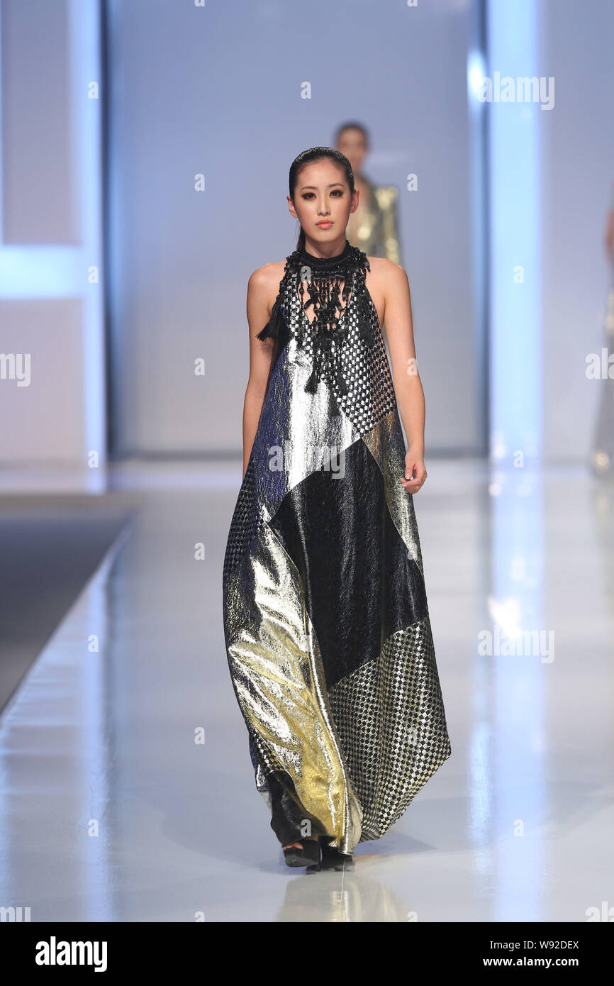 A model displays a new creation by Chinese brother designers Wu Xuewei ...