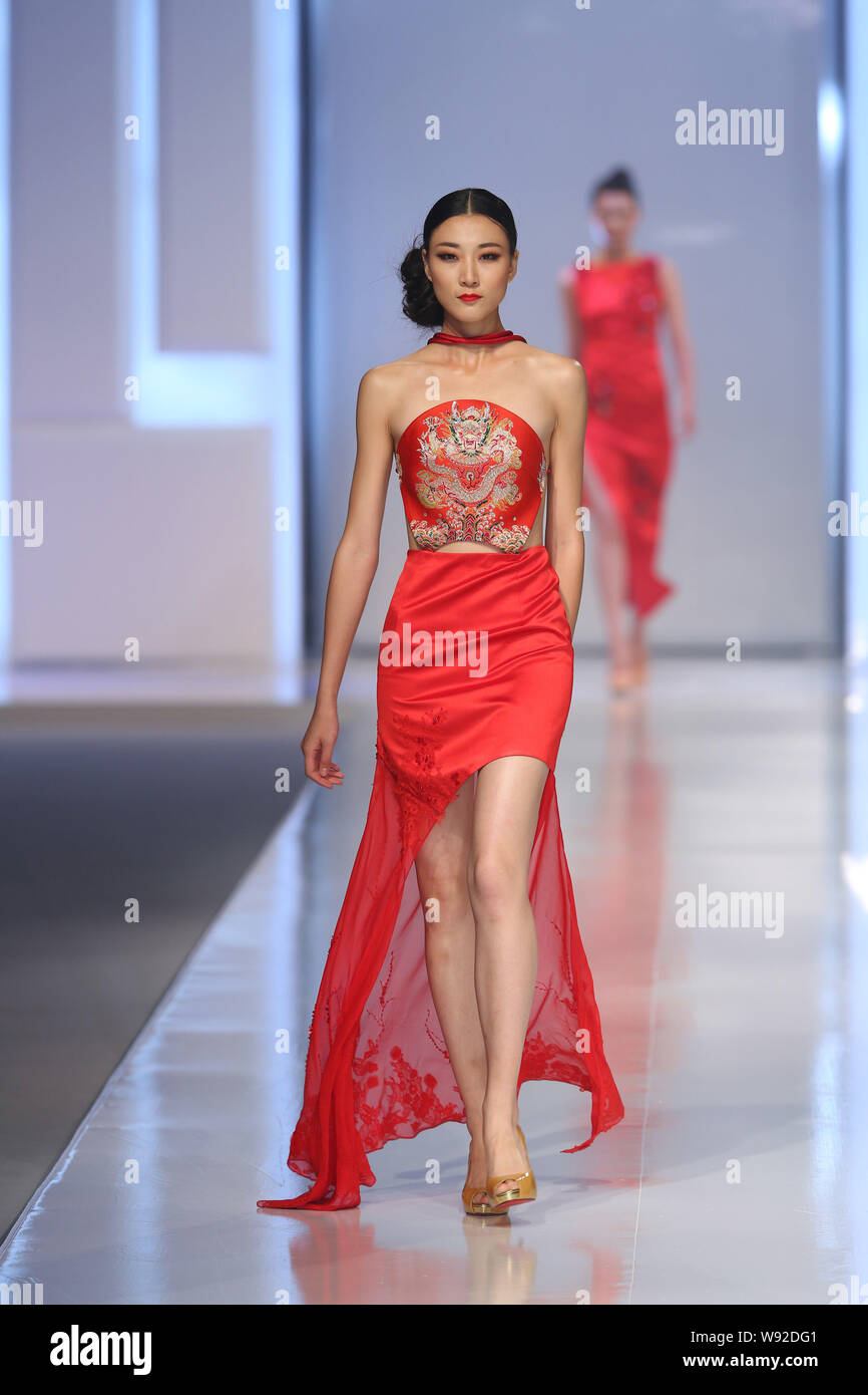 A model displays a new creation by Chinese brother designers Wu Xuewei ...