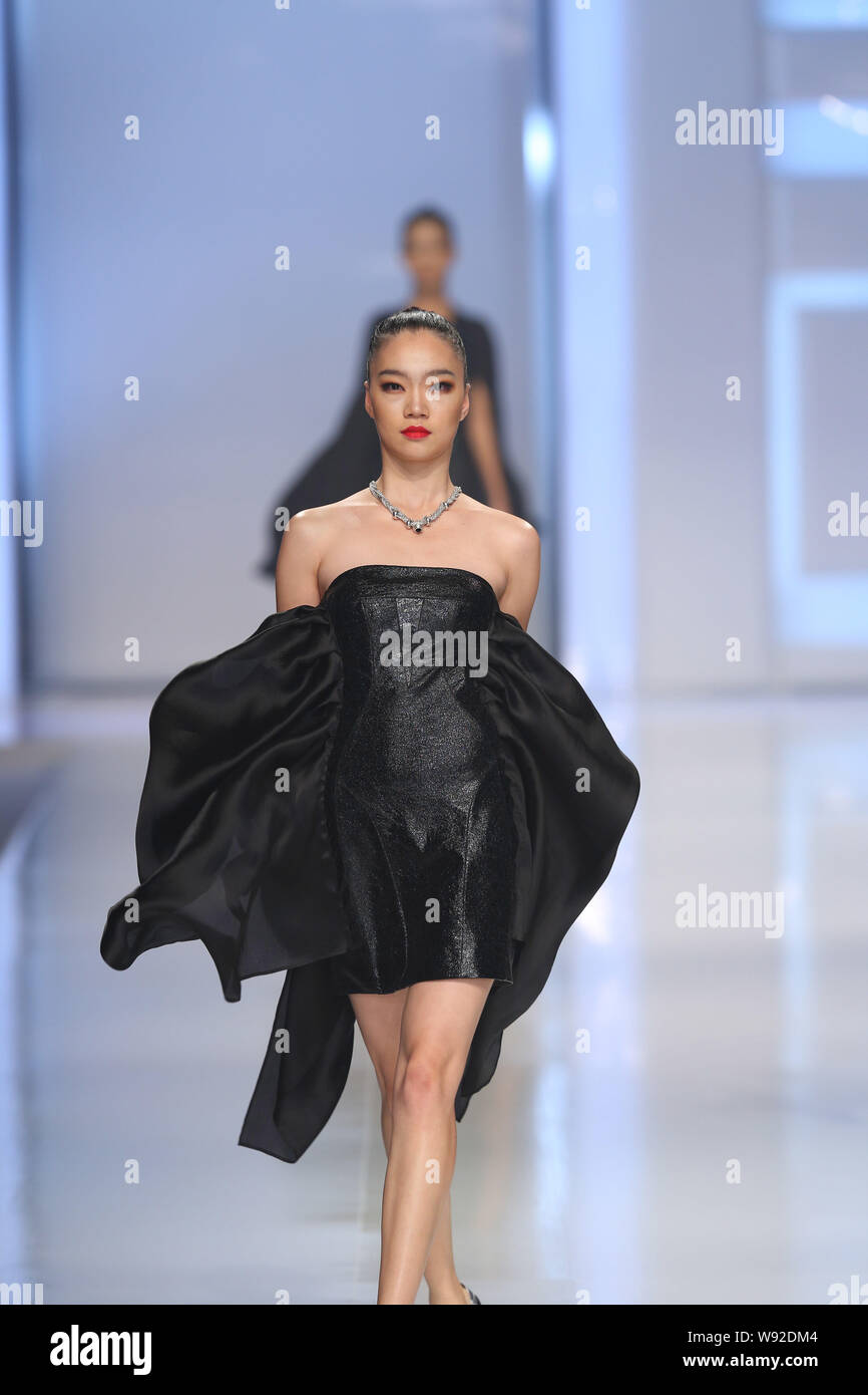 A model displays a new creation by Chinese brother designers Wu Xuewei ...