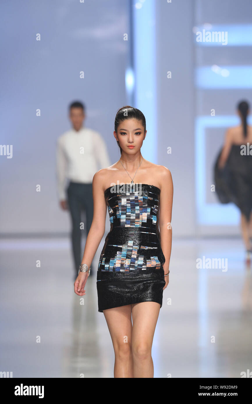 A model displays a new creation by Chinese brother designers Wu Xuewei ...