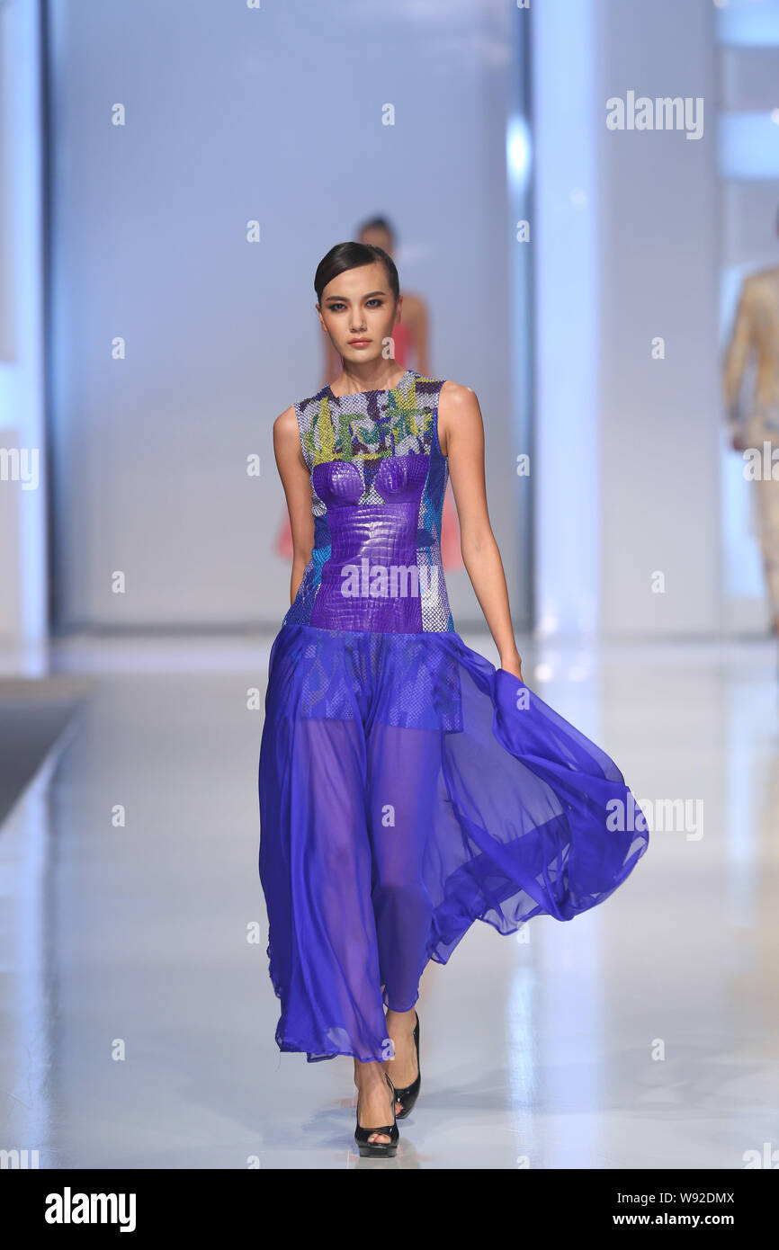 A model displays a new creation by Chinese brother designers Wu Xuewei ...