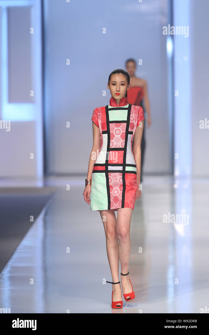 A model displays a new creation by Chinese brother designers Wu Xuewei ...