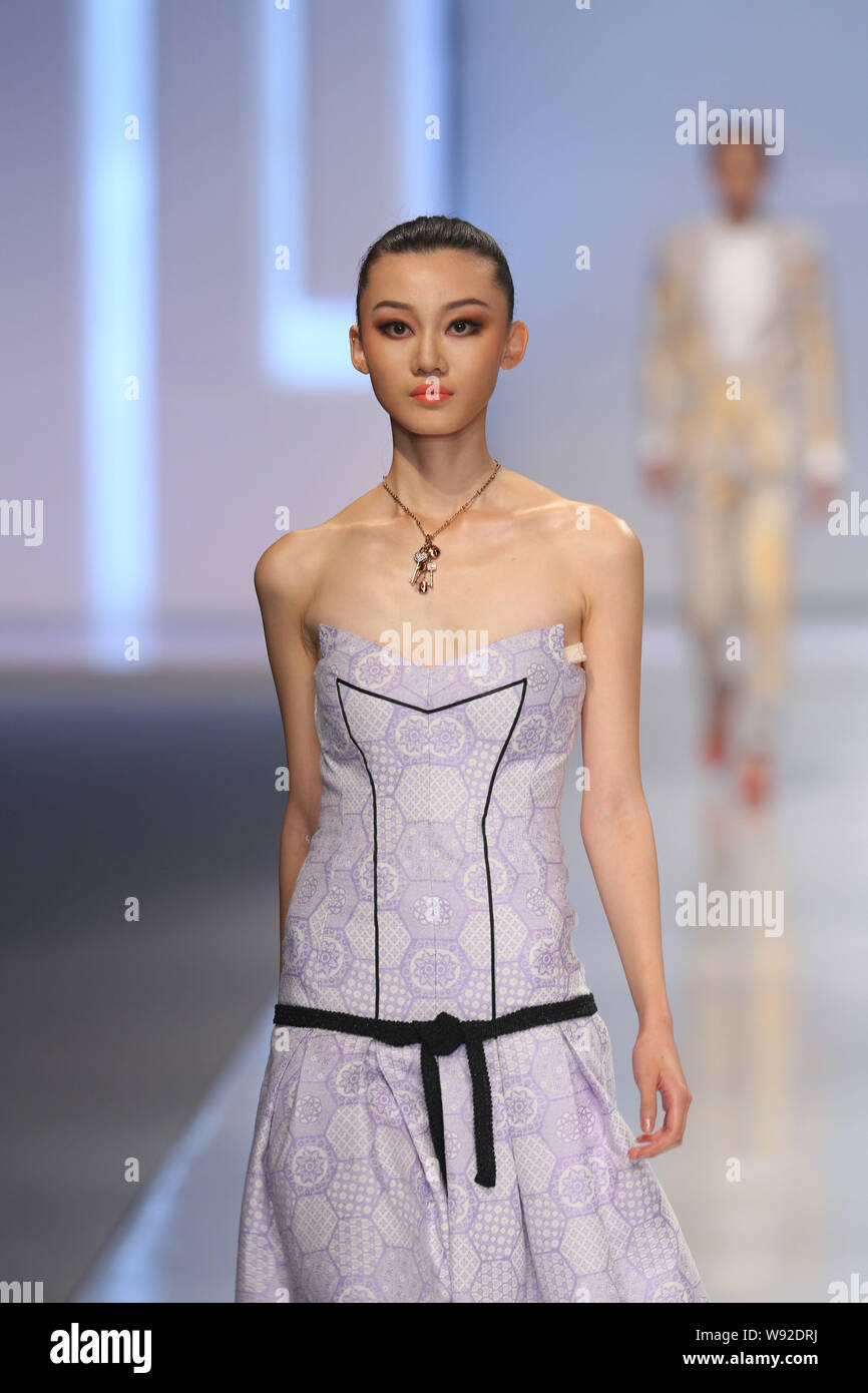 A model displays a new creation by Chinese brother designers Wu Xuewei ...