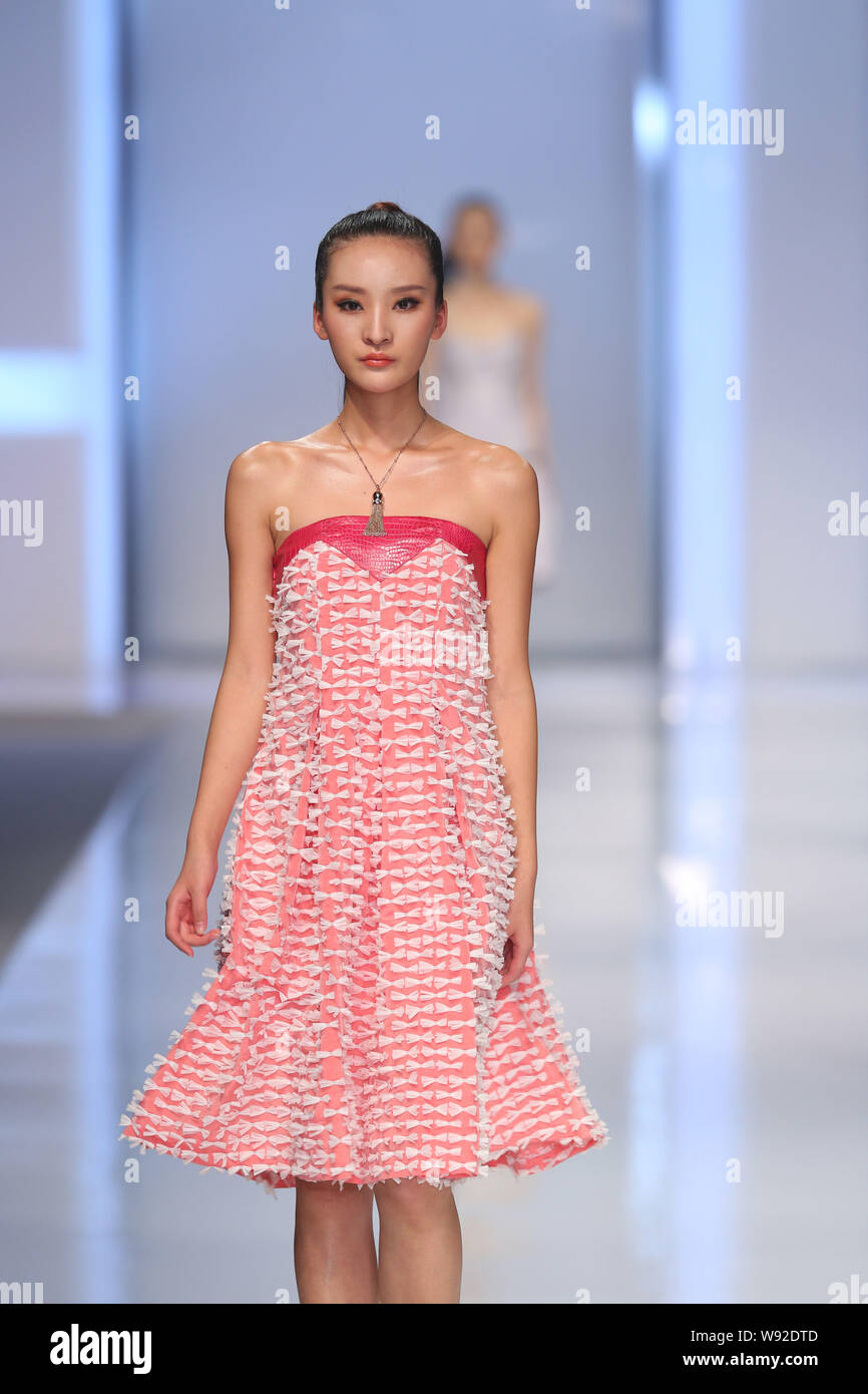 A model displays a new creation by Chinese brother designers Wu Xuewei ...